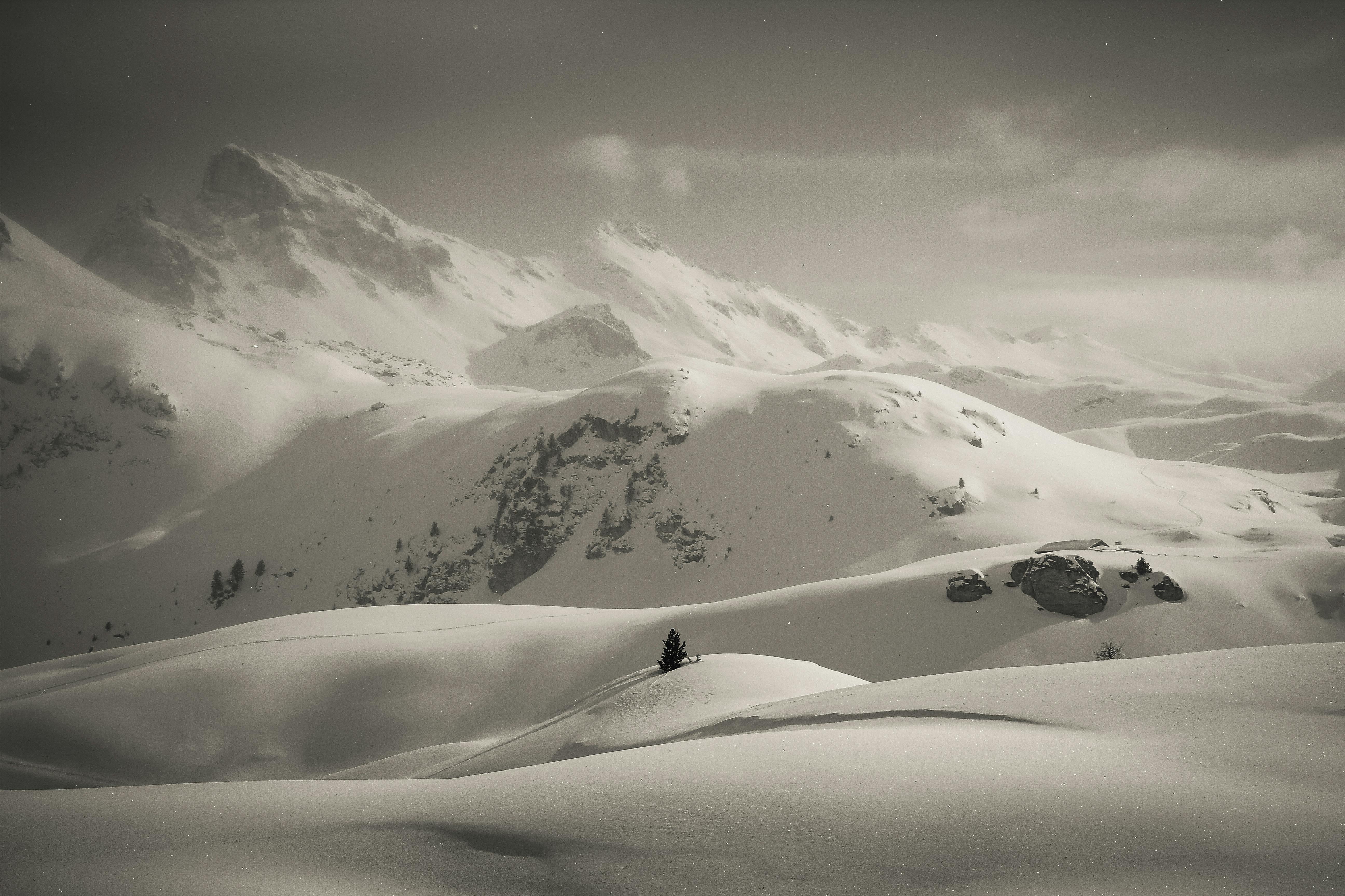 Grayscale Photo of Snow-Covered Mountains · Free Stock Photo