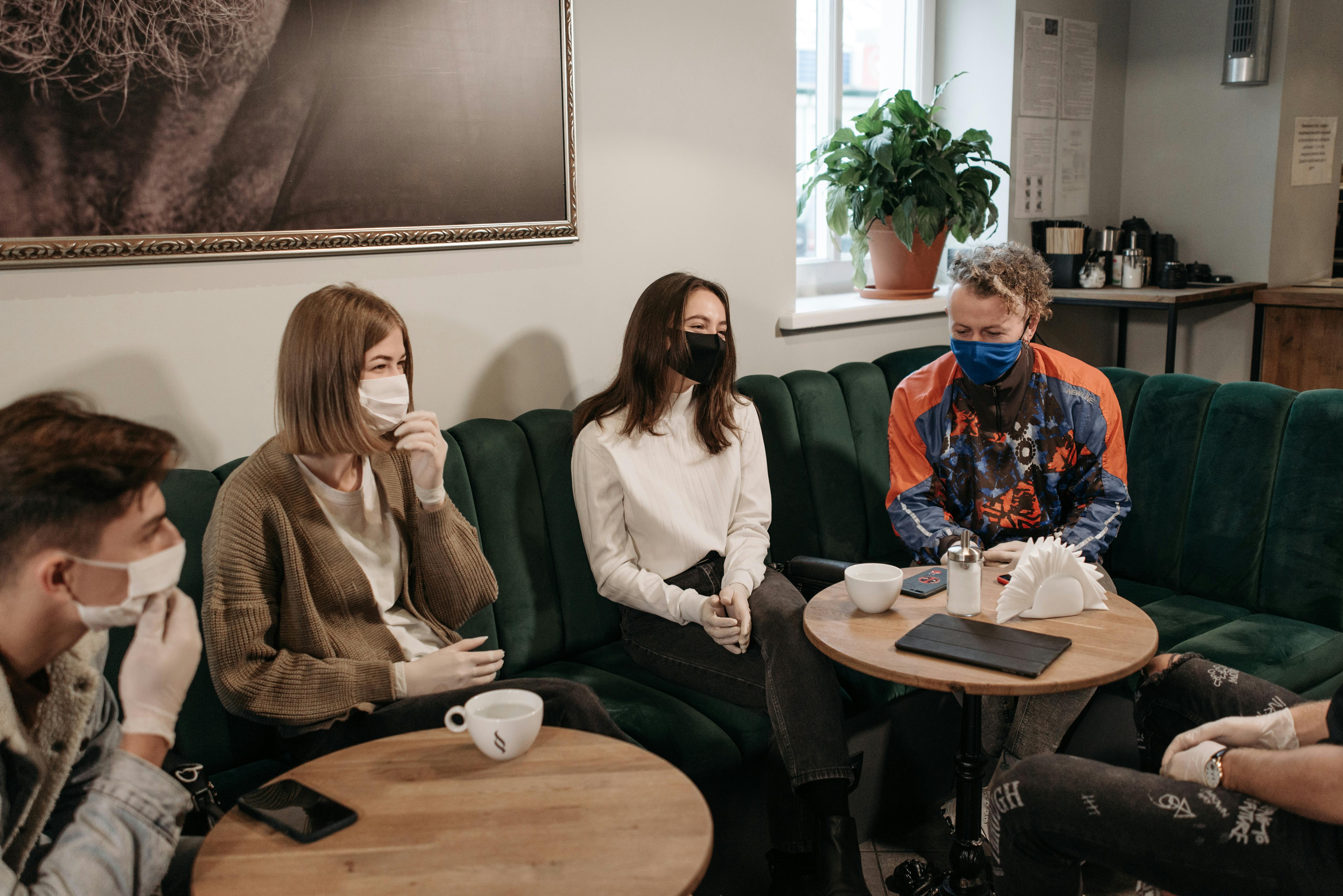 People Sitting on a Sofa in a Coffee Shop · Free Stock Photo