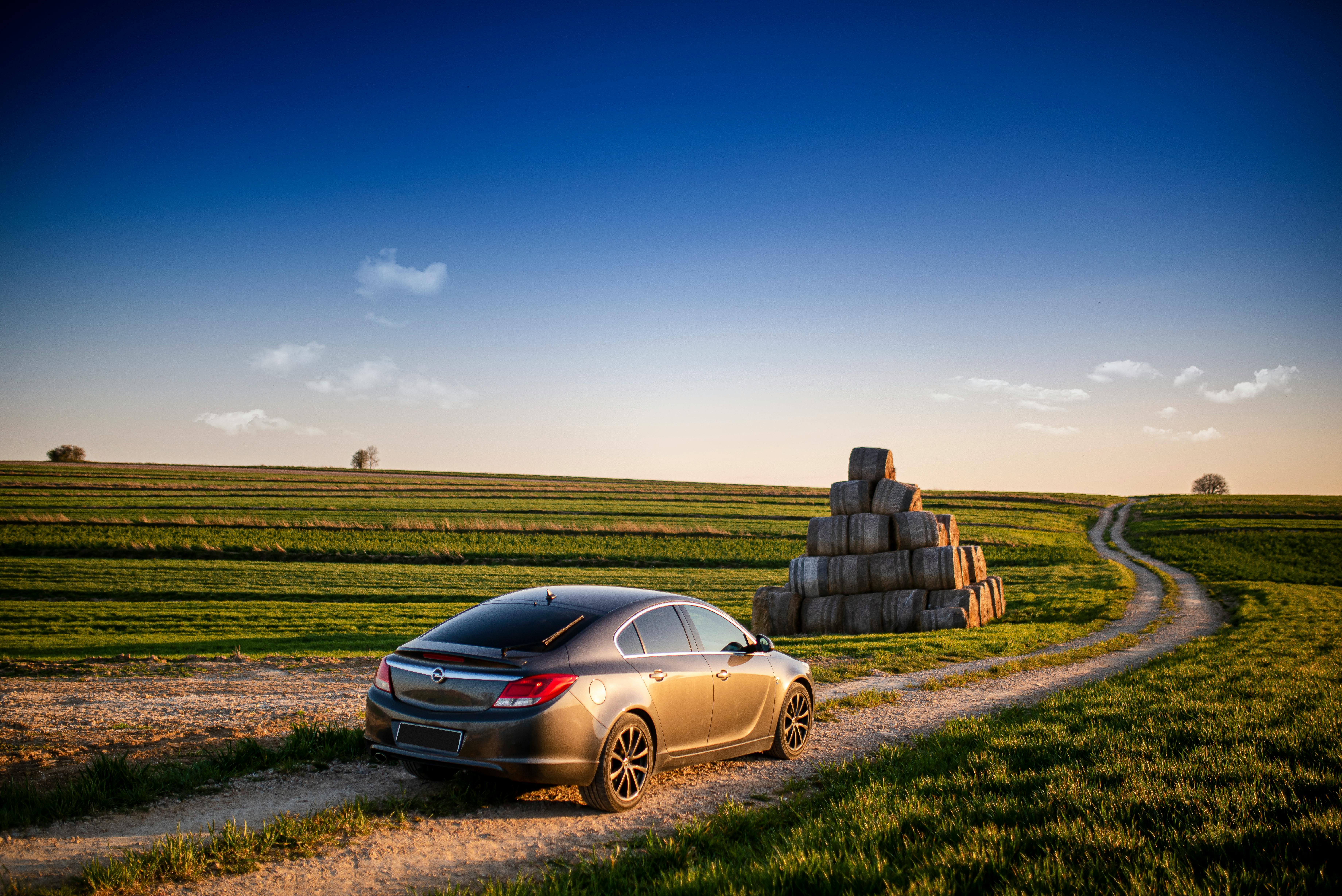 Shiny car parked on countryside field · Free Stock Photo