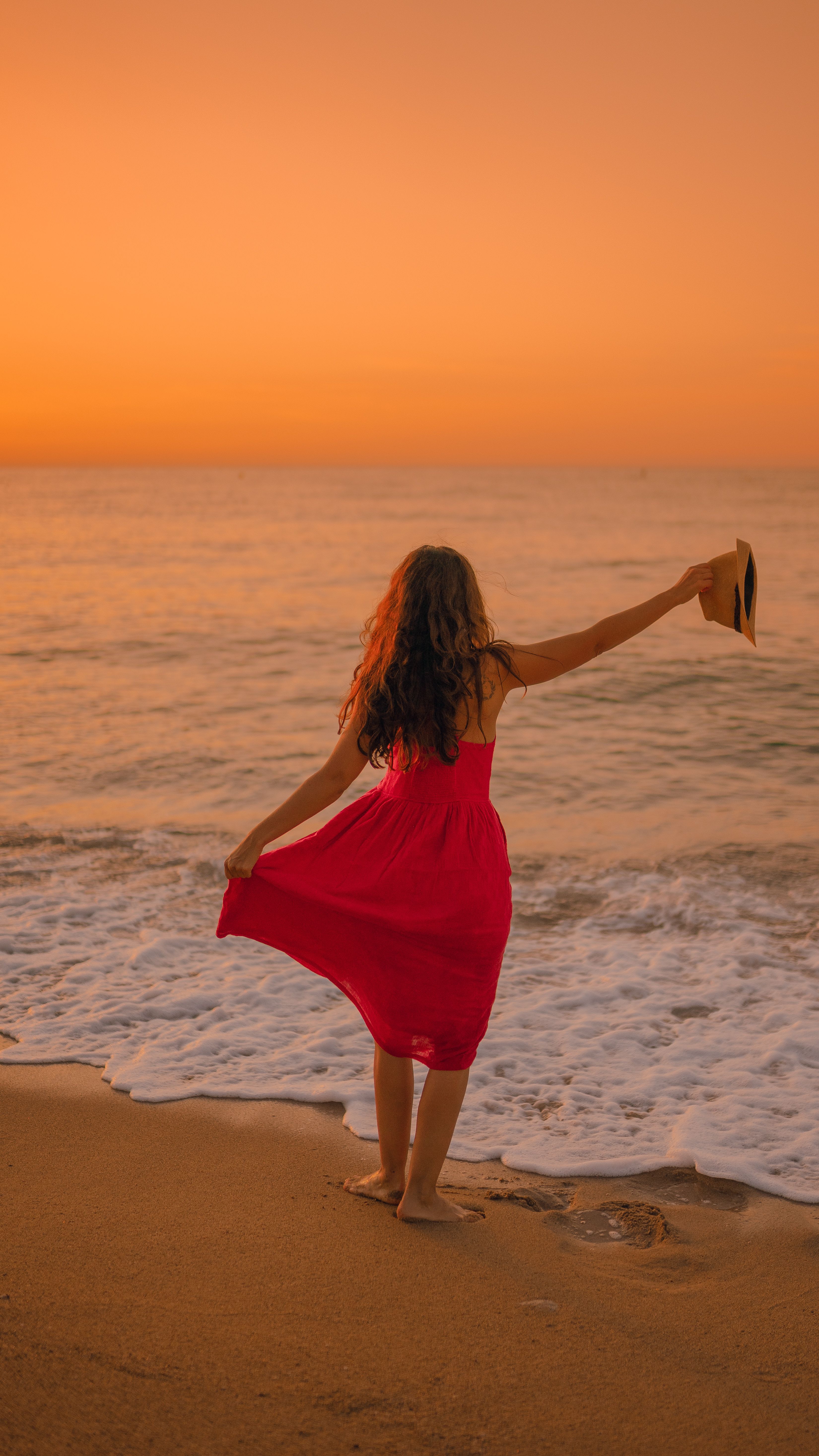 Group of people enjoying sunset on seashore · Free Stock Photo