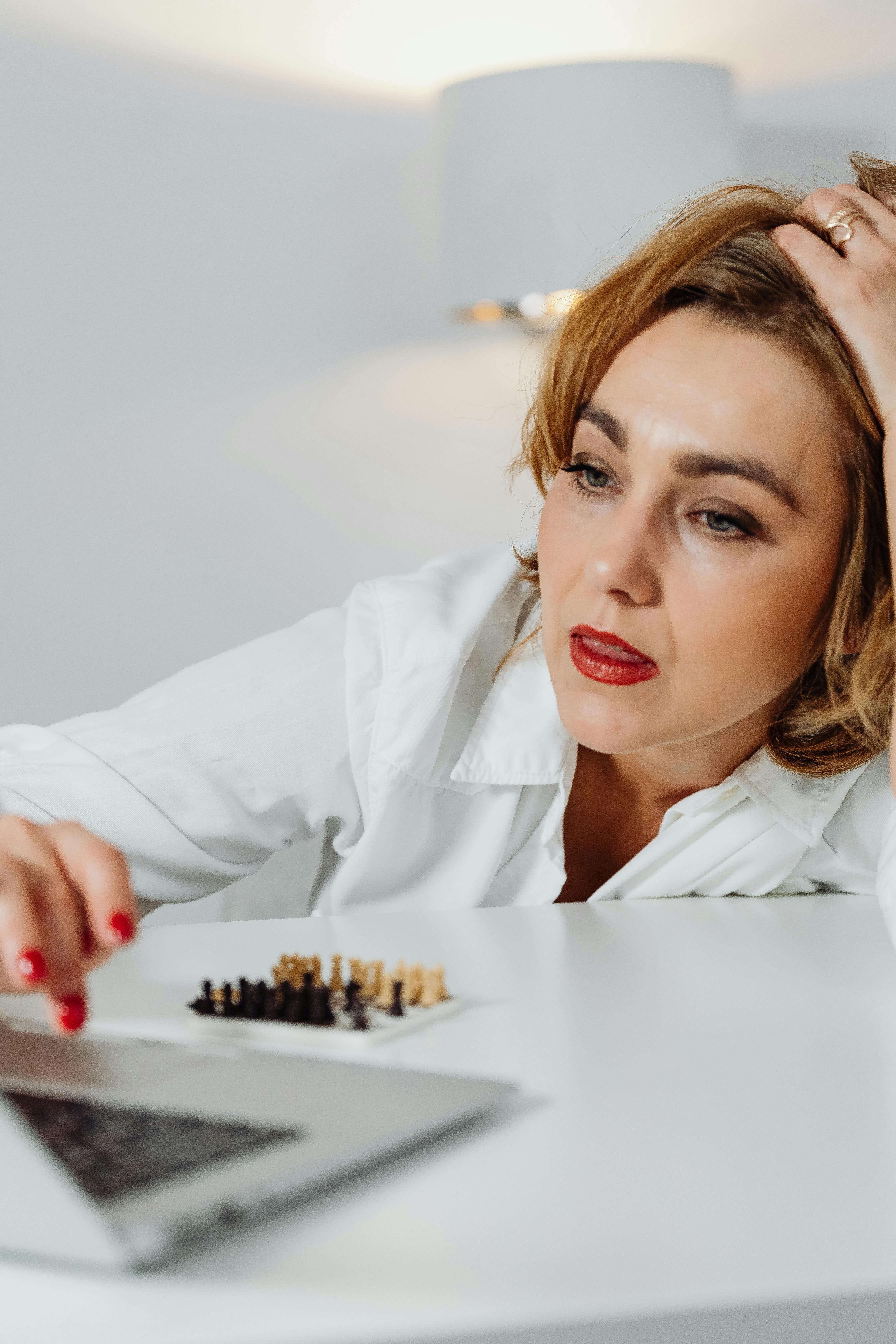 Tired Woman Playing Chess During Work · Free Stock Photo