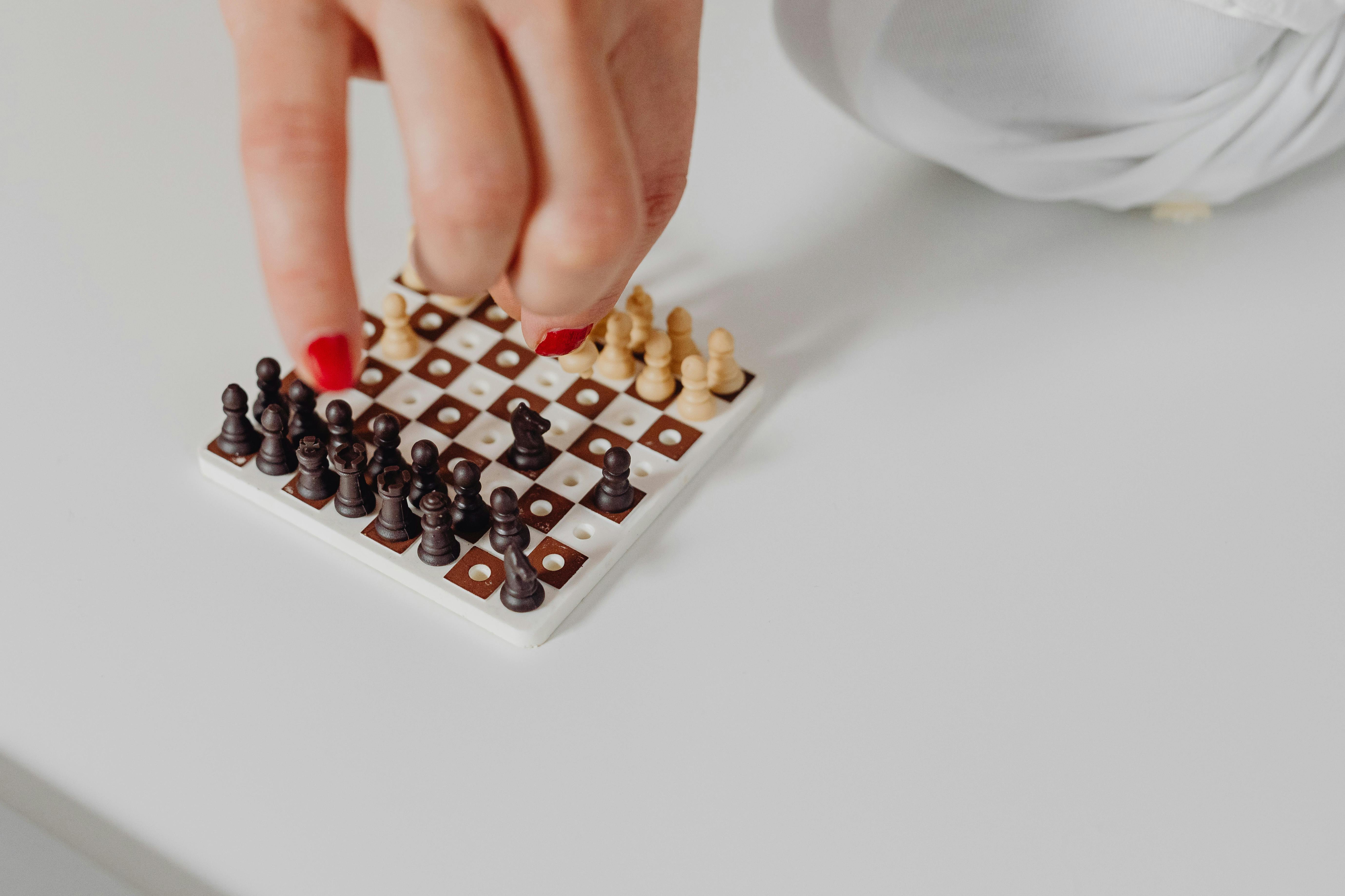 Miniature Chess Pieces on a Chessboard · Free Stock Photo