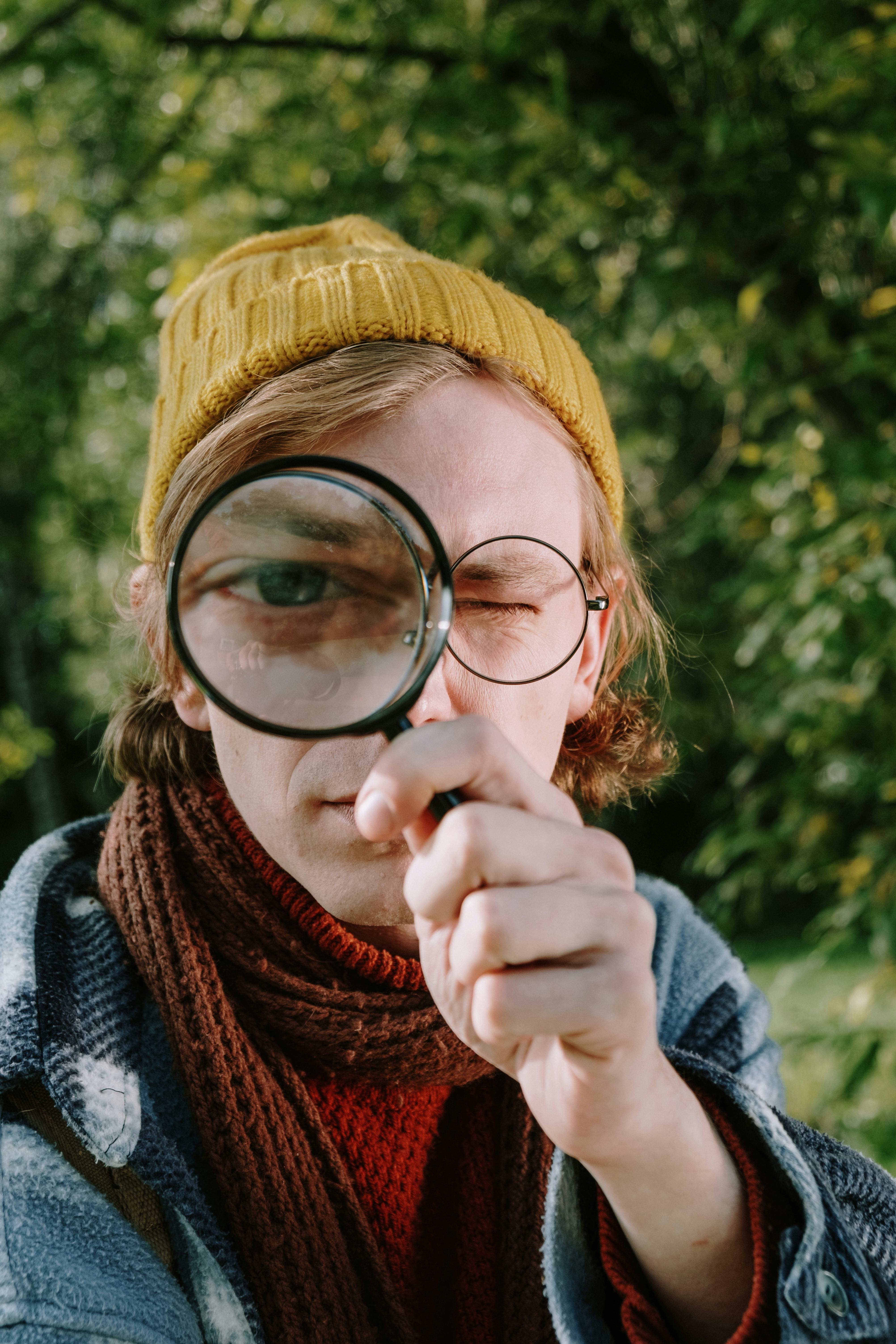Person Holding a Magnifying Glass · Free Stock Photo