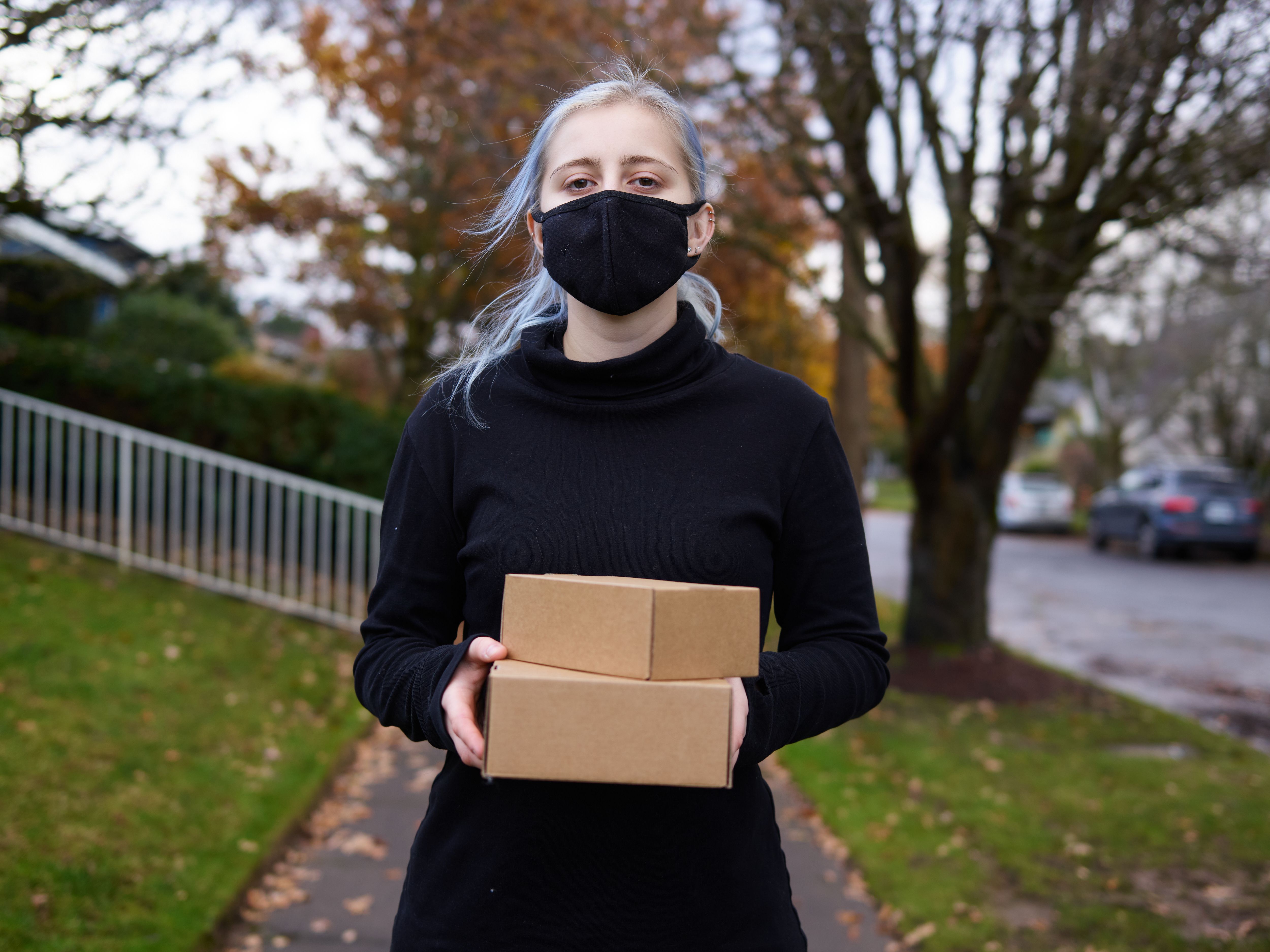 Woman with a Box on her Head with a Sad Face Drawn on It · Free Stock Photo