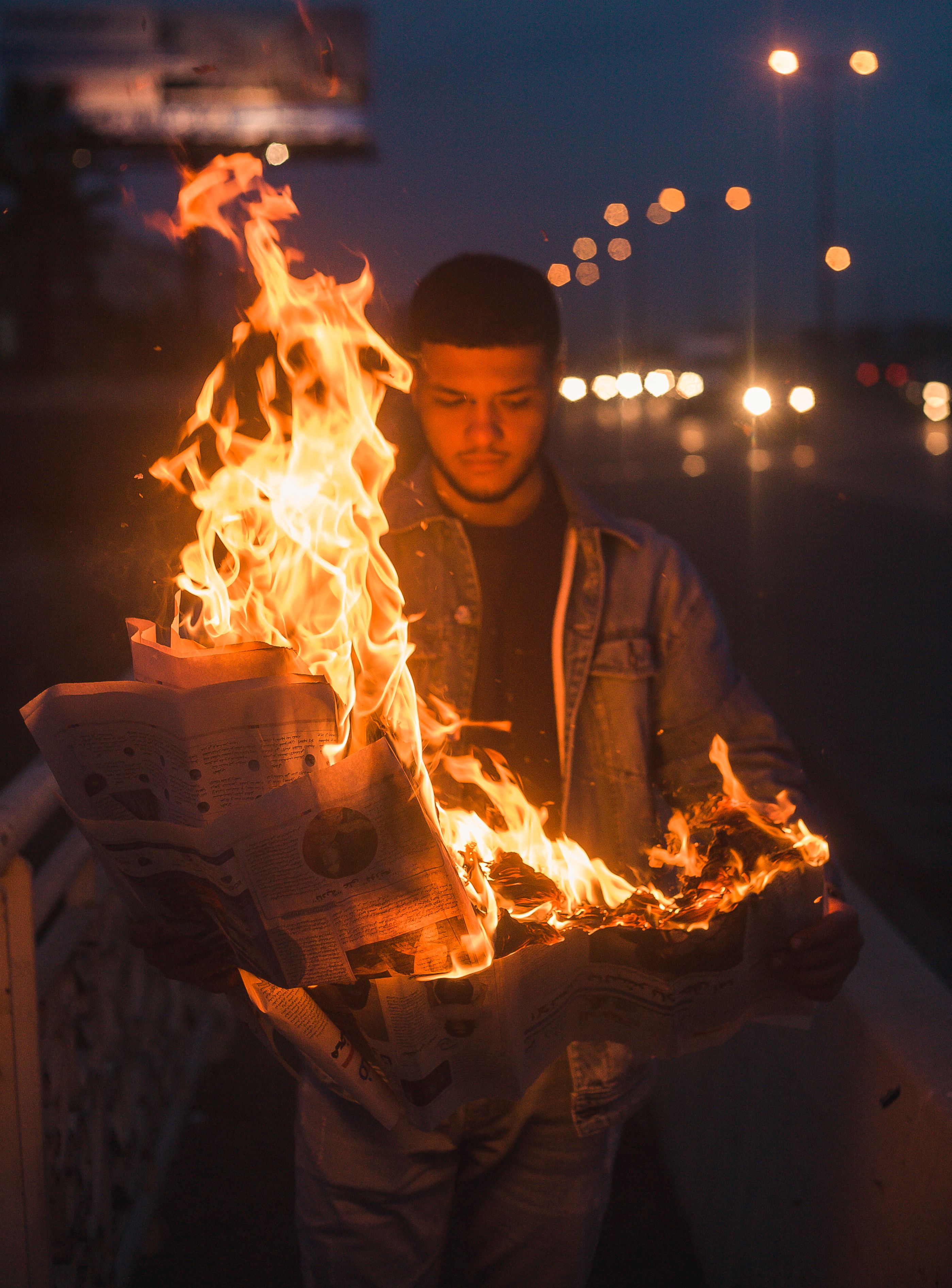 Portrait of an African Man Holding Burning Paper · Free Stock Photo