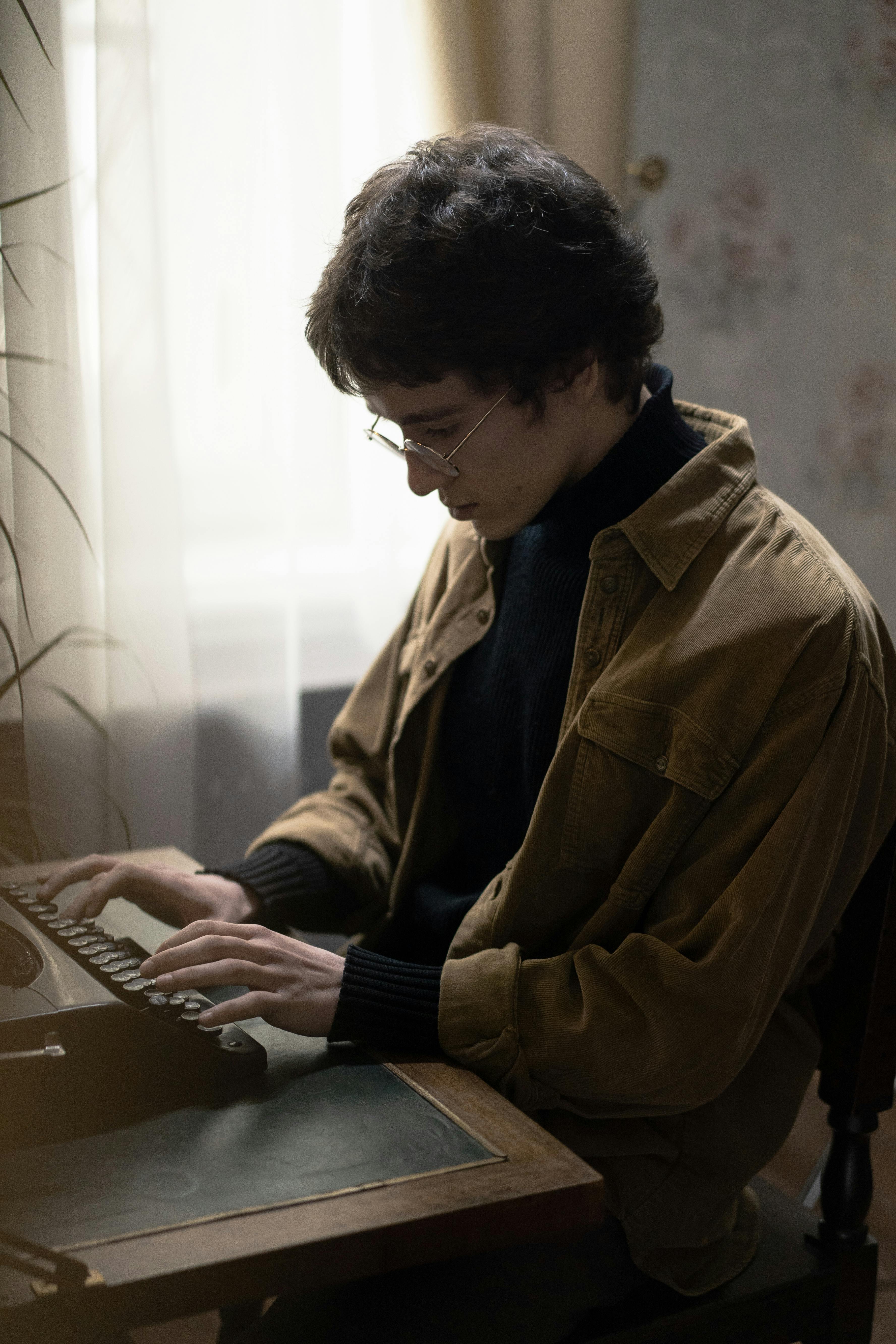 Man Typing on the Black Vintage Typewriter · Free Stock Photo