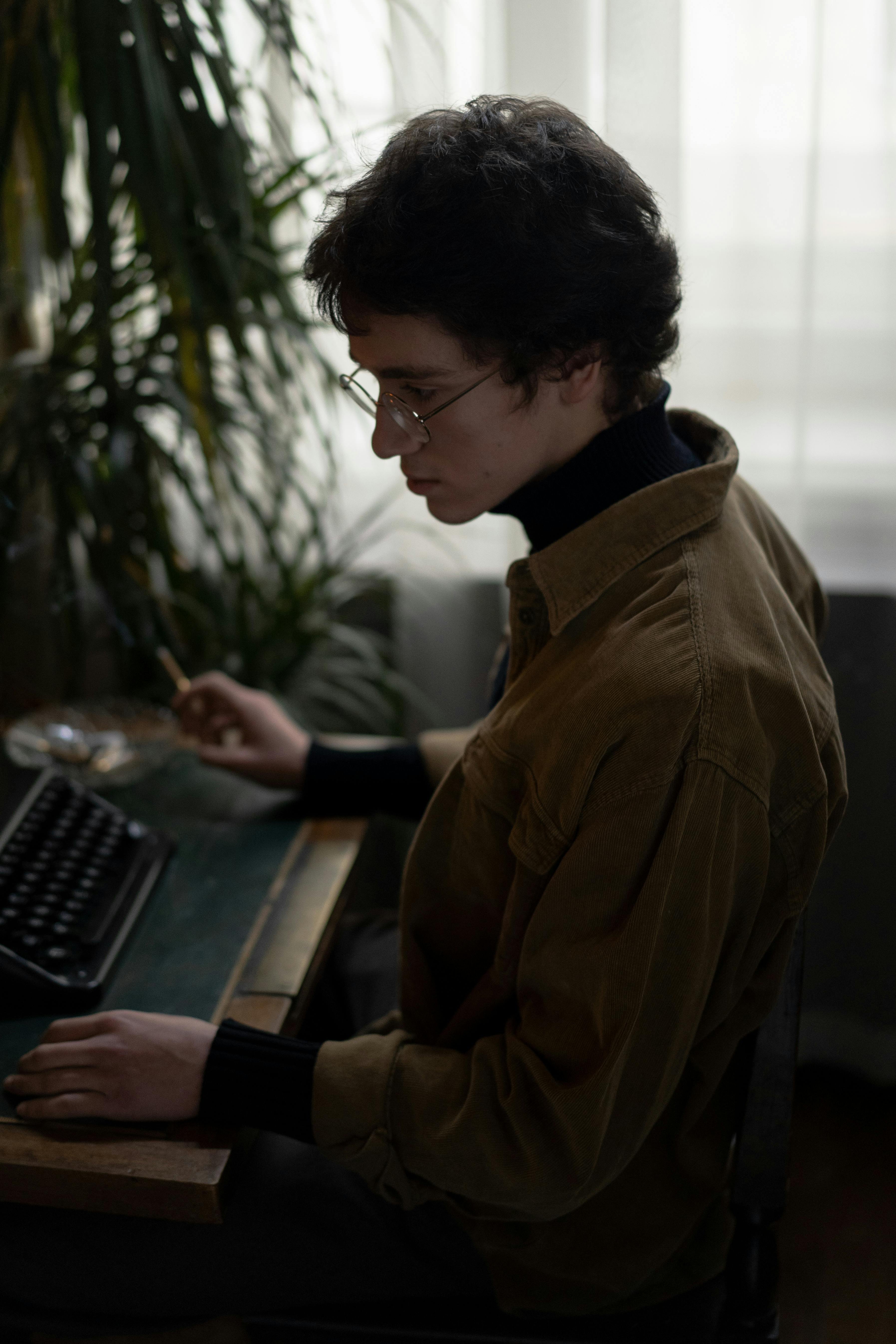 Man in Brown Coat Using Black Laptop Computer · Free Stock Photo