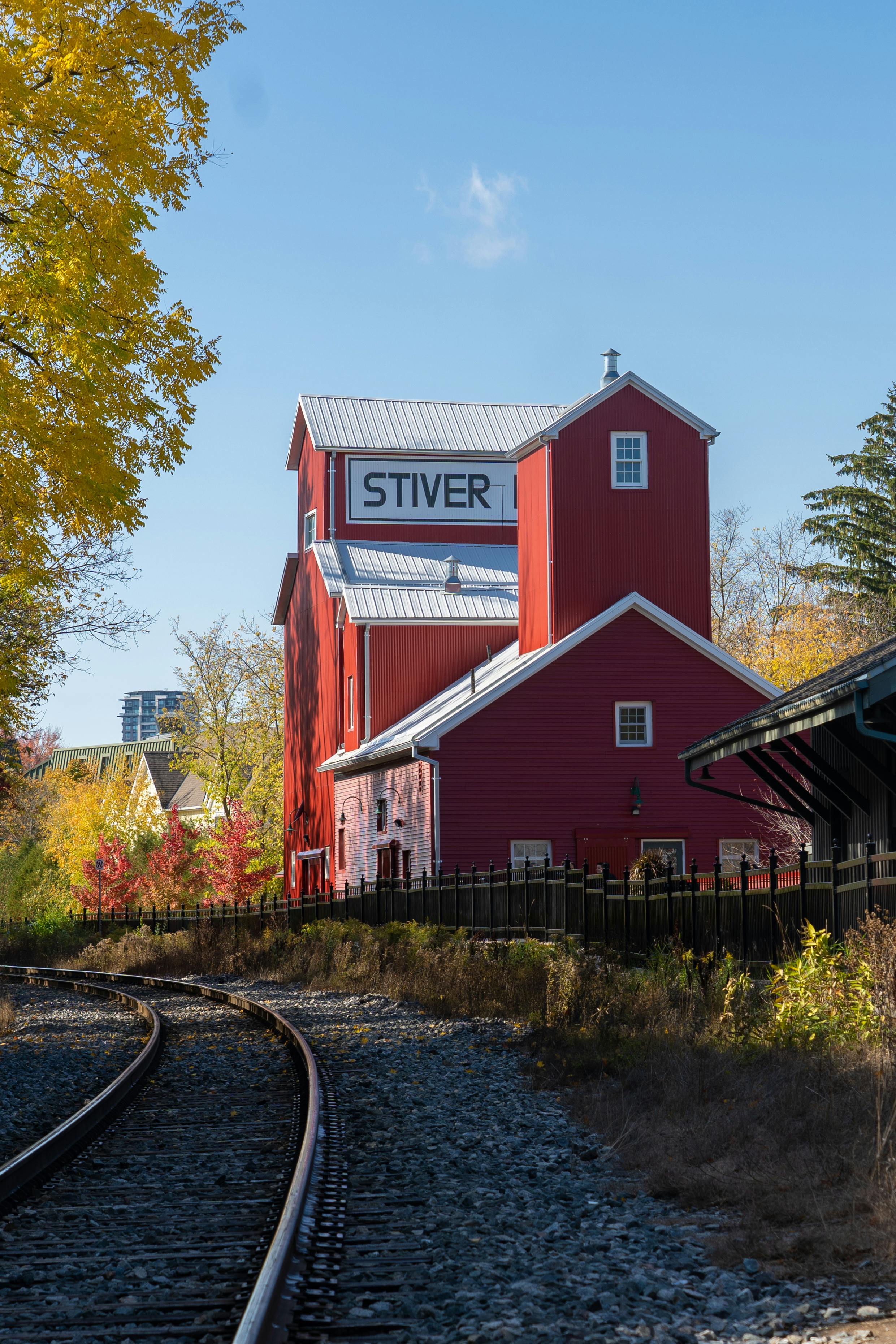 Red and White Building Near a Railway · Free Stock Photo