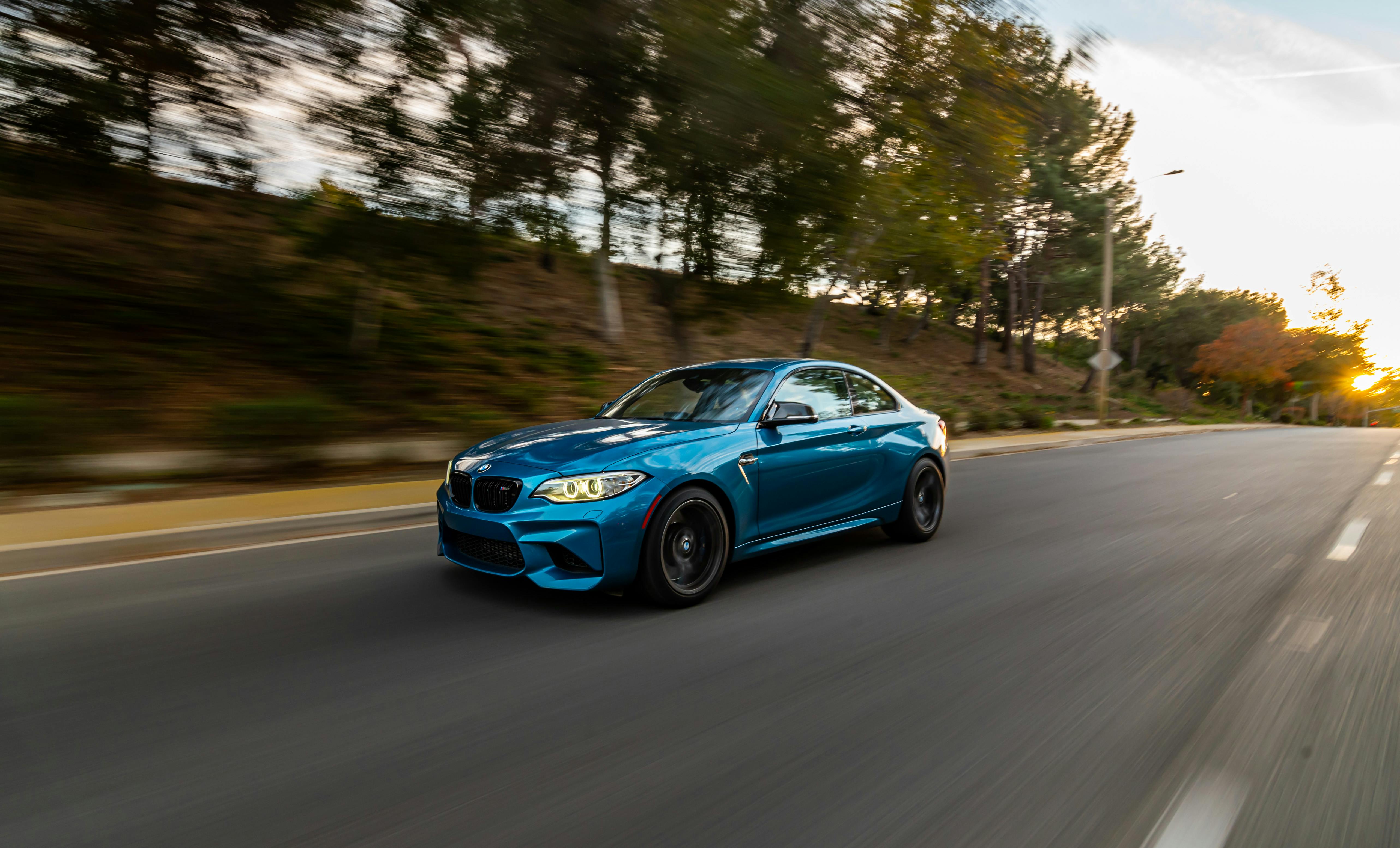 Blue Sportscar Driving Down the Road · Free Stock Photo
