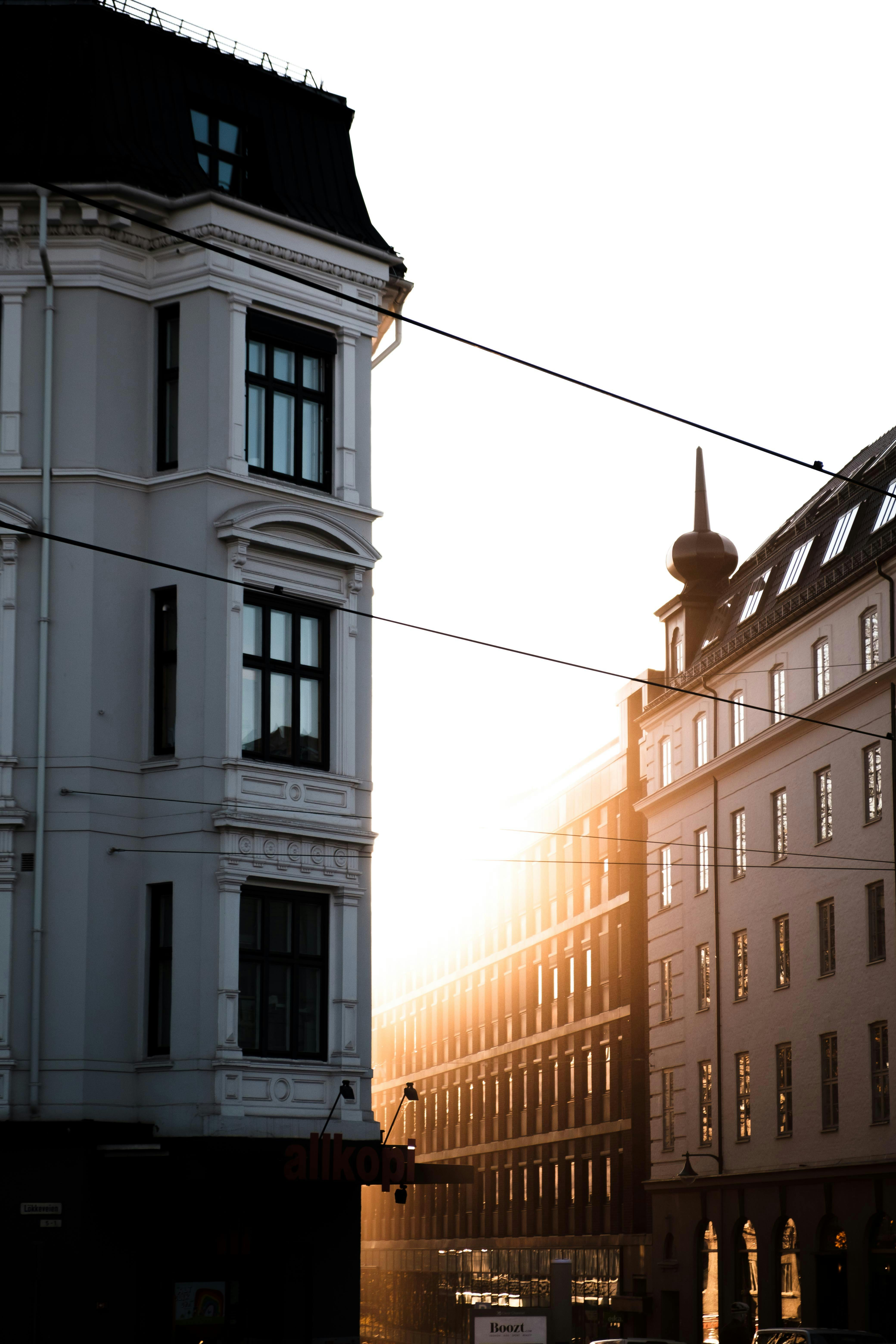 Sun Setting Behind Buildings in City · Free Stock Photo