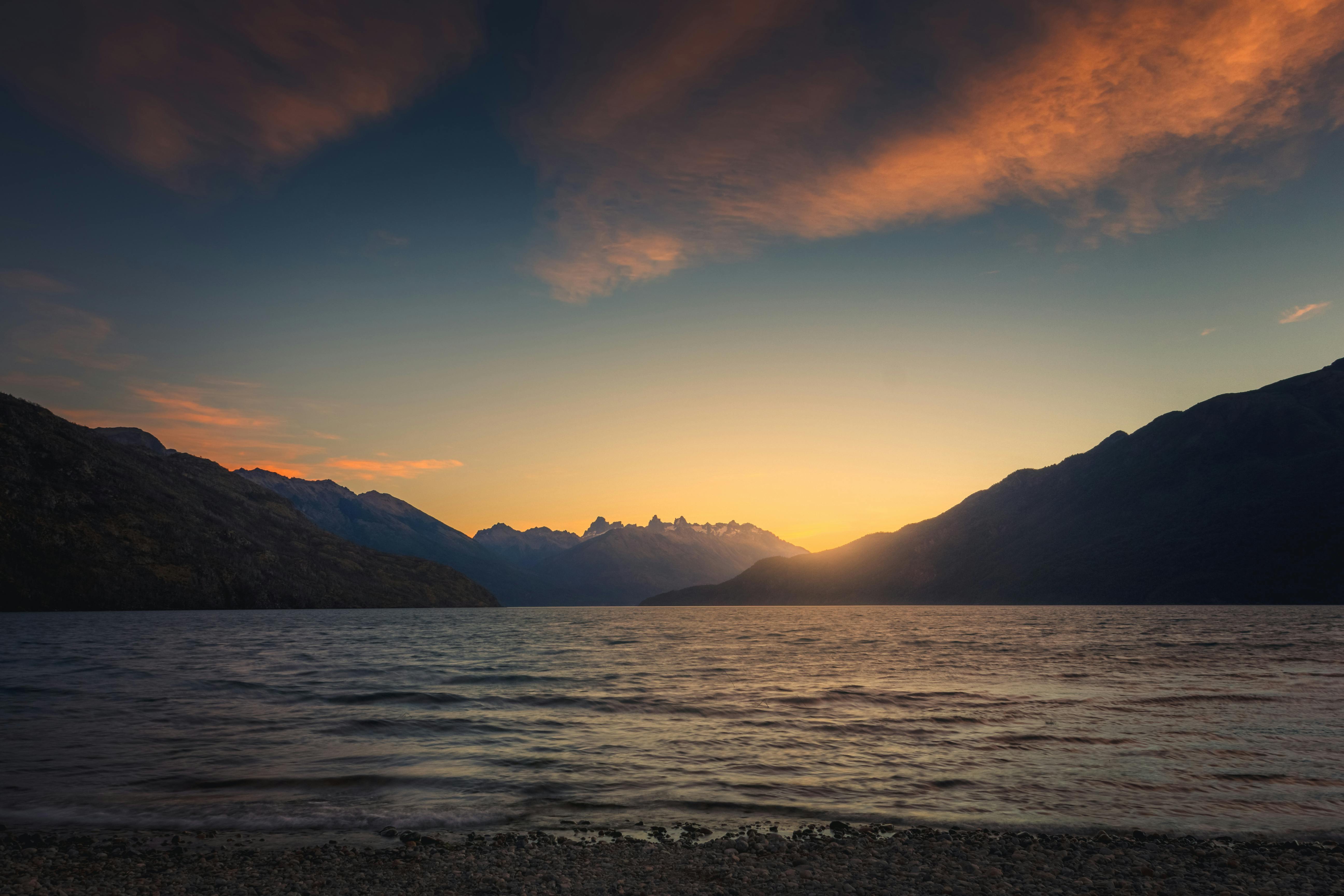Sun Setting Behind Mountains and a Mountain Lake · Free Stock Photo