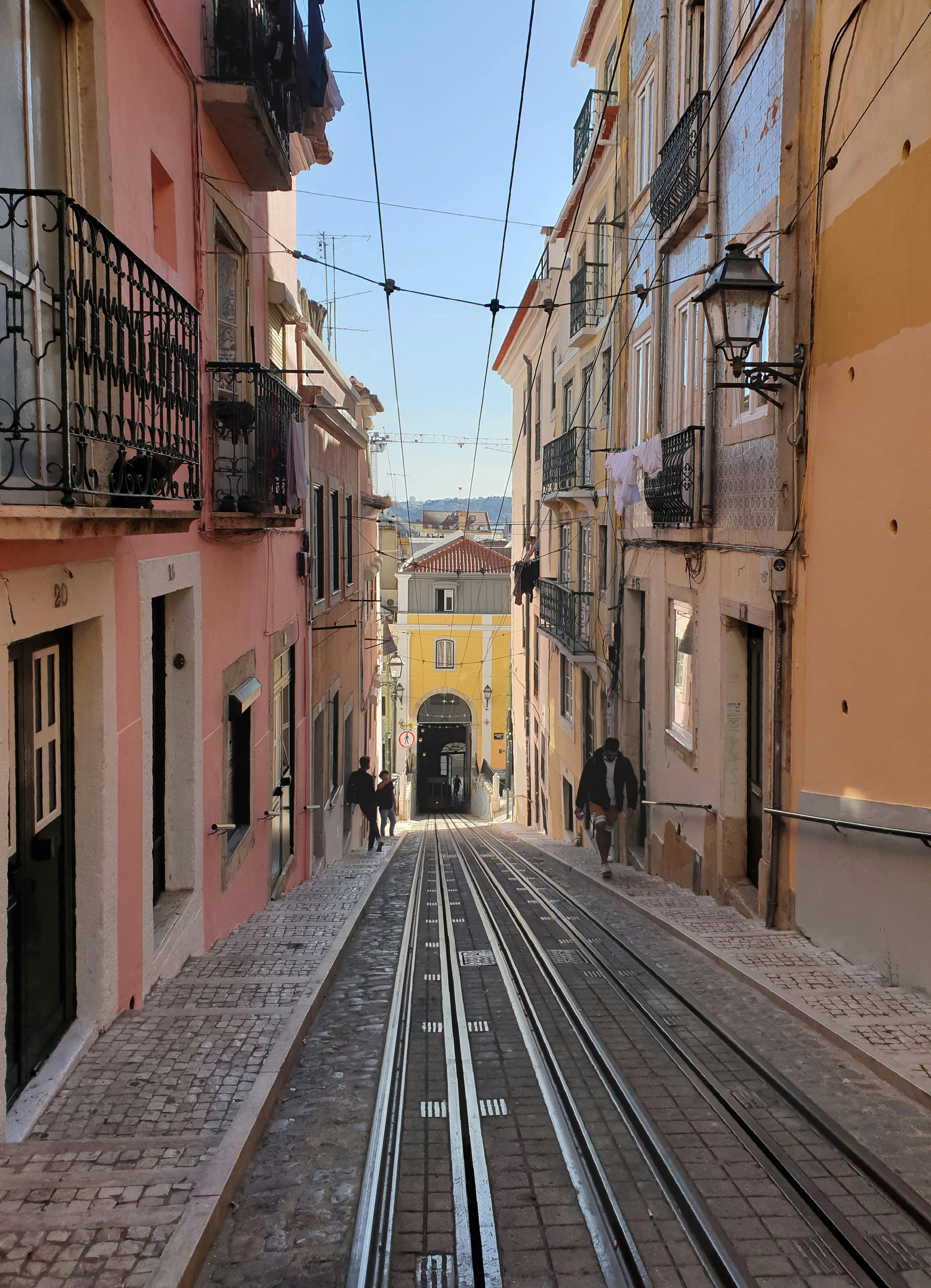 A Train Rail Between Concrete Buildings · Free Stock Photo