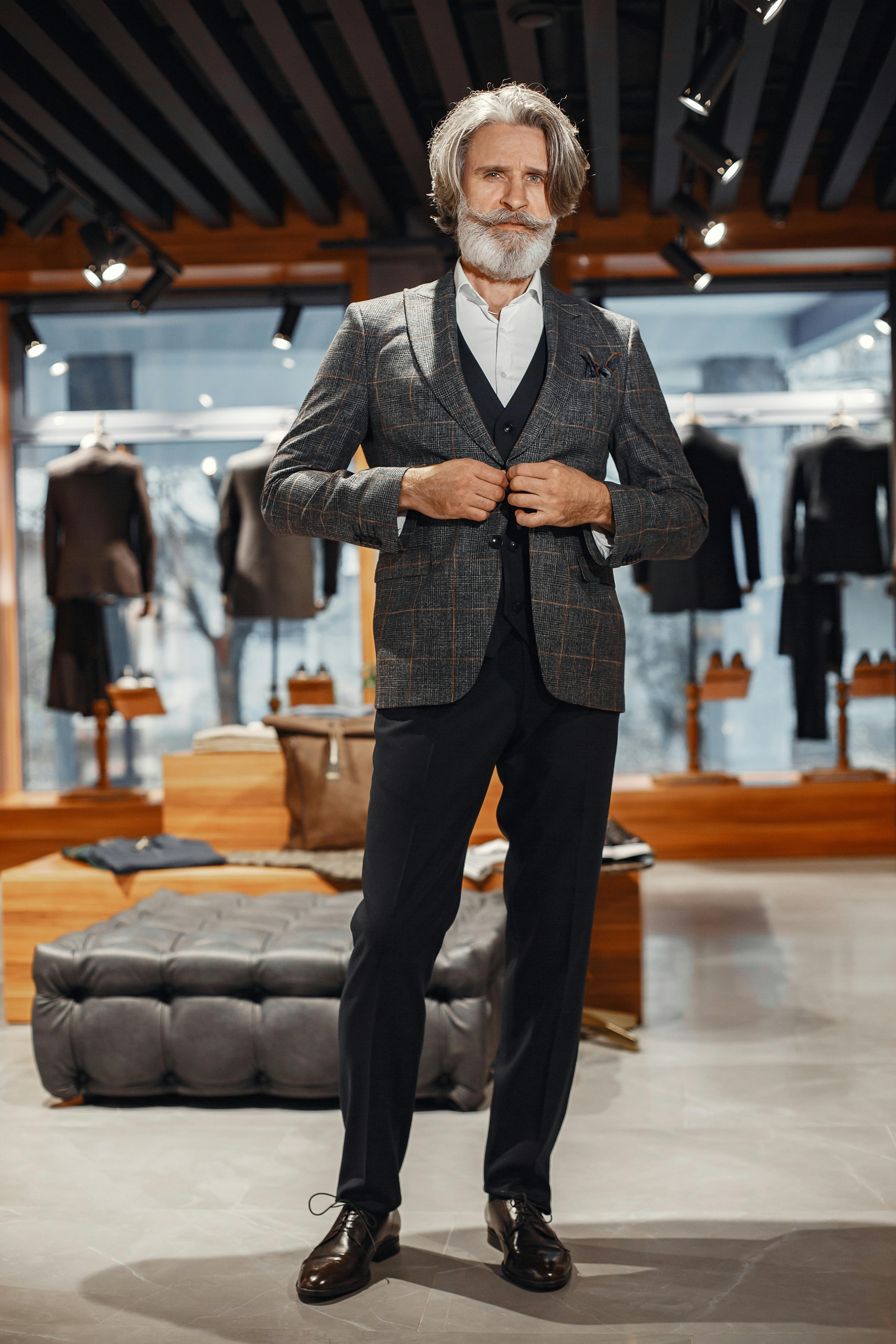 Middle Aged Man Trying on Suit in a Clothing Store · Free Stock Photo