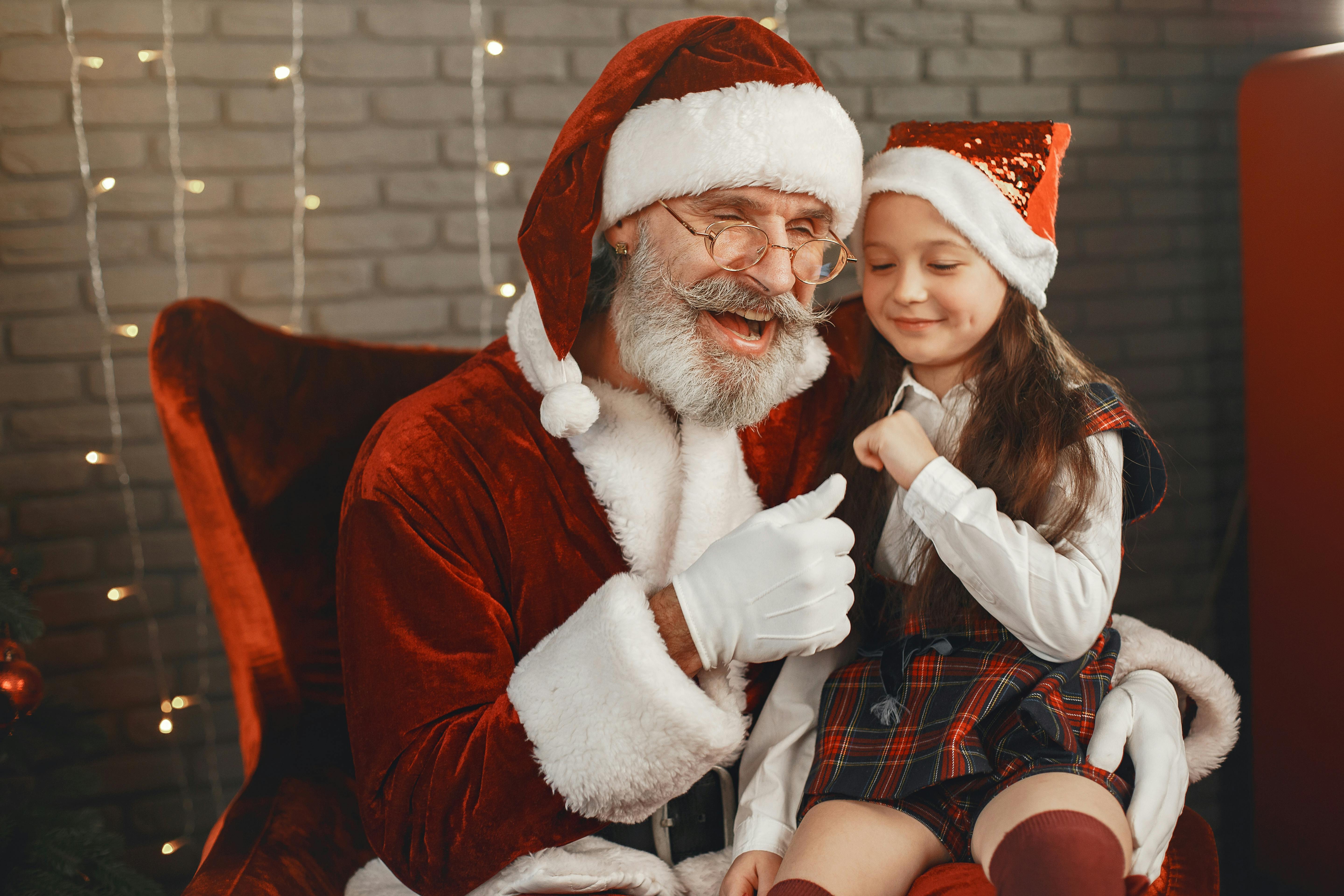Little Girl Whispering into Santa Ear · Free Stock Photo