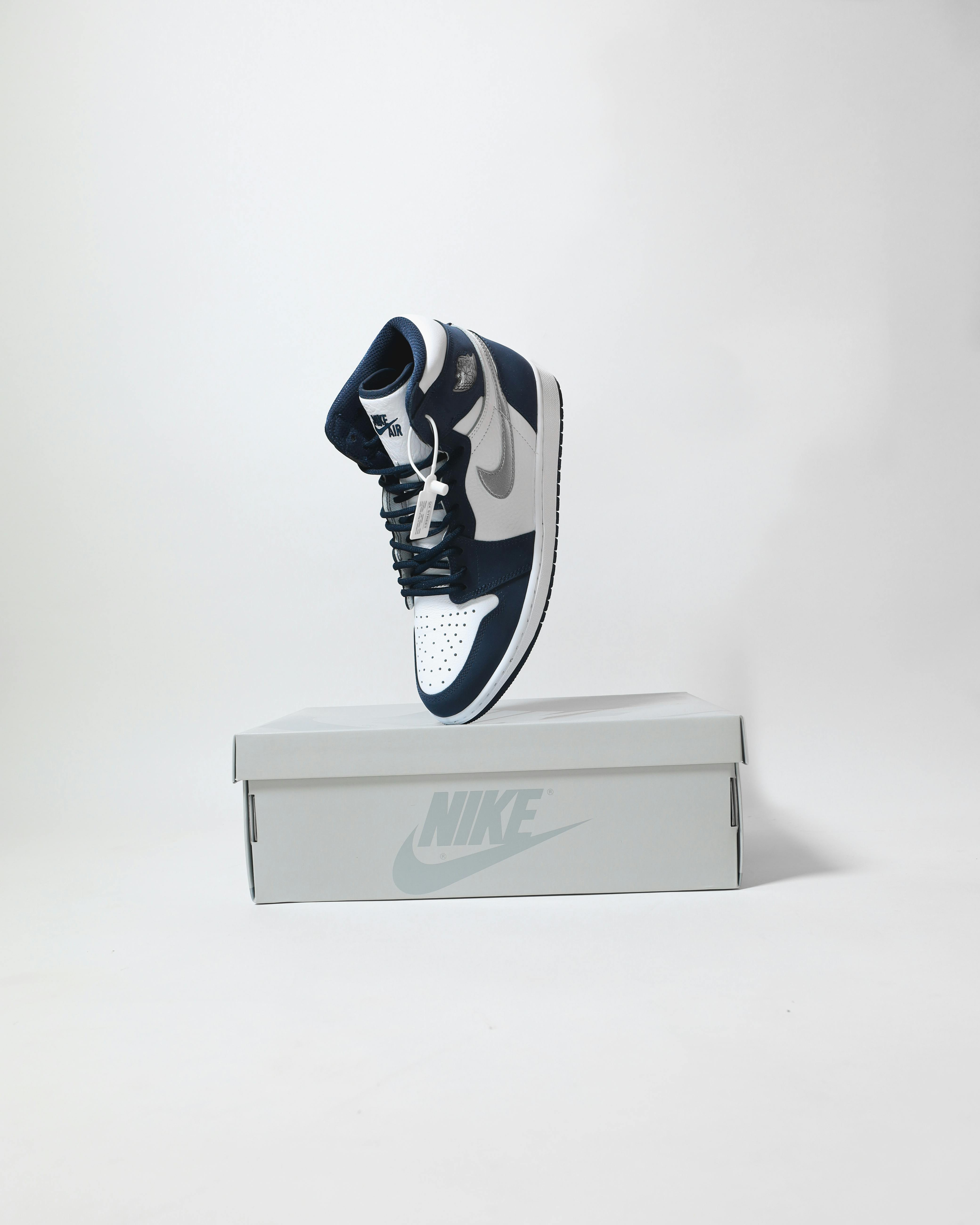 Sports Shoe Balancing on Shoe Box · Free Stock Photo