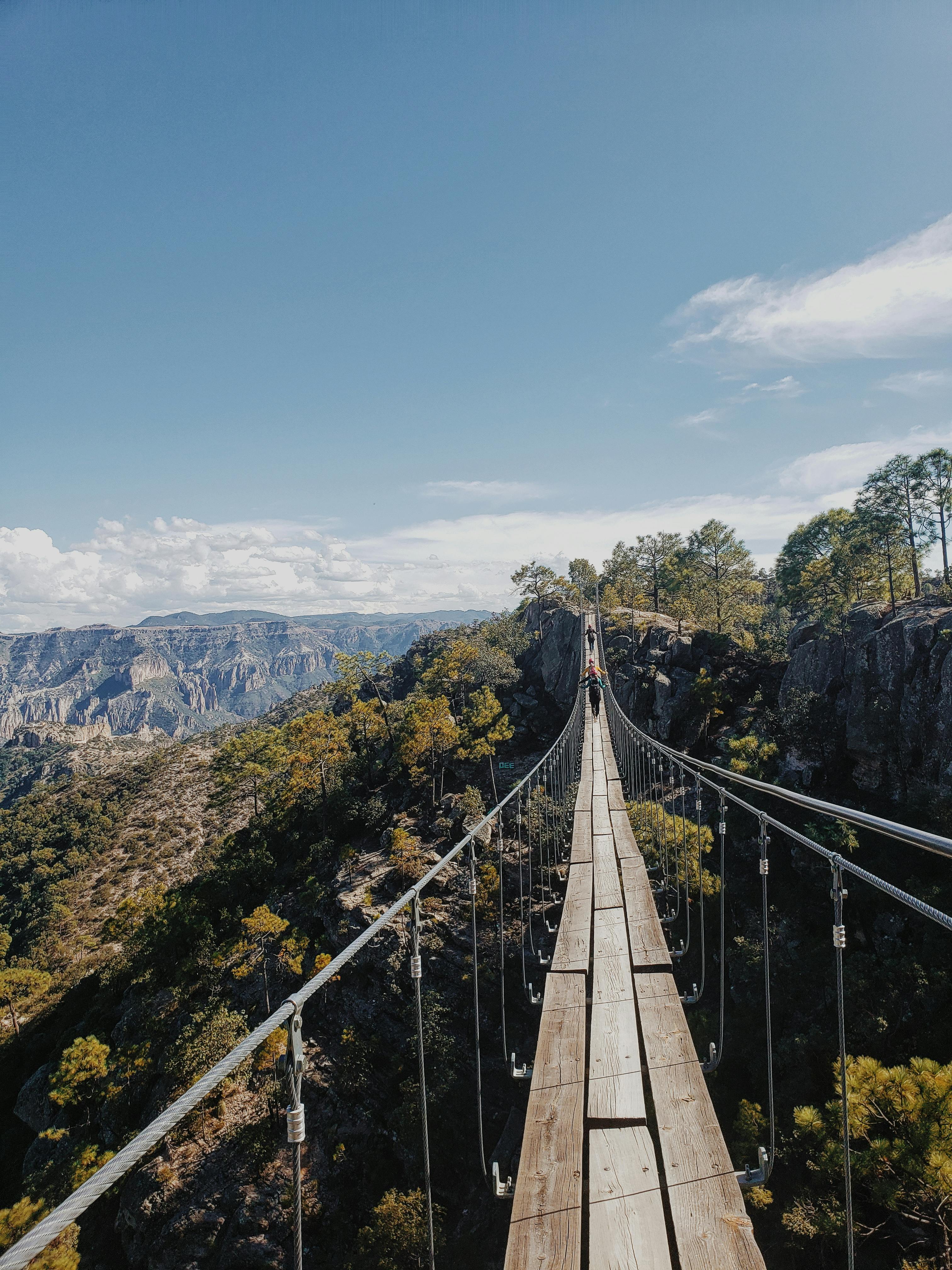Brown Wooden Bridge over Green Mountains · Free Stock Photo