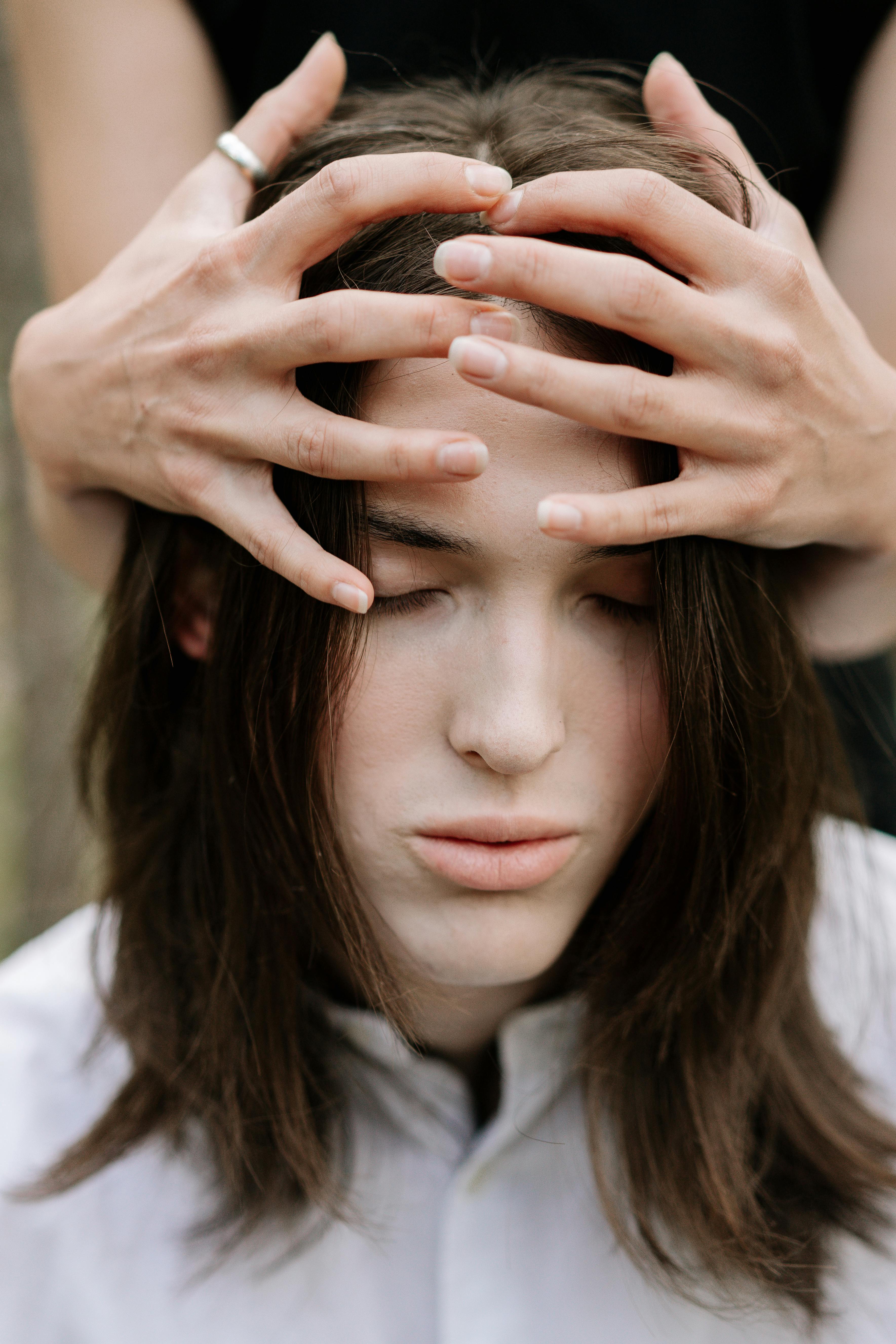 Hands Covering a Man's Forehead · Free Stock Photo