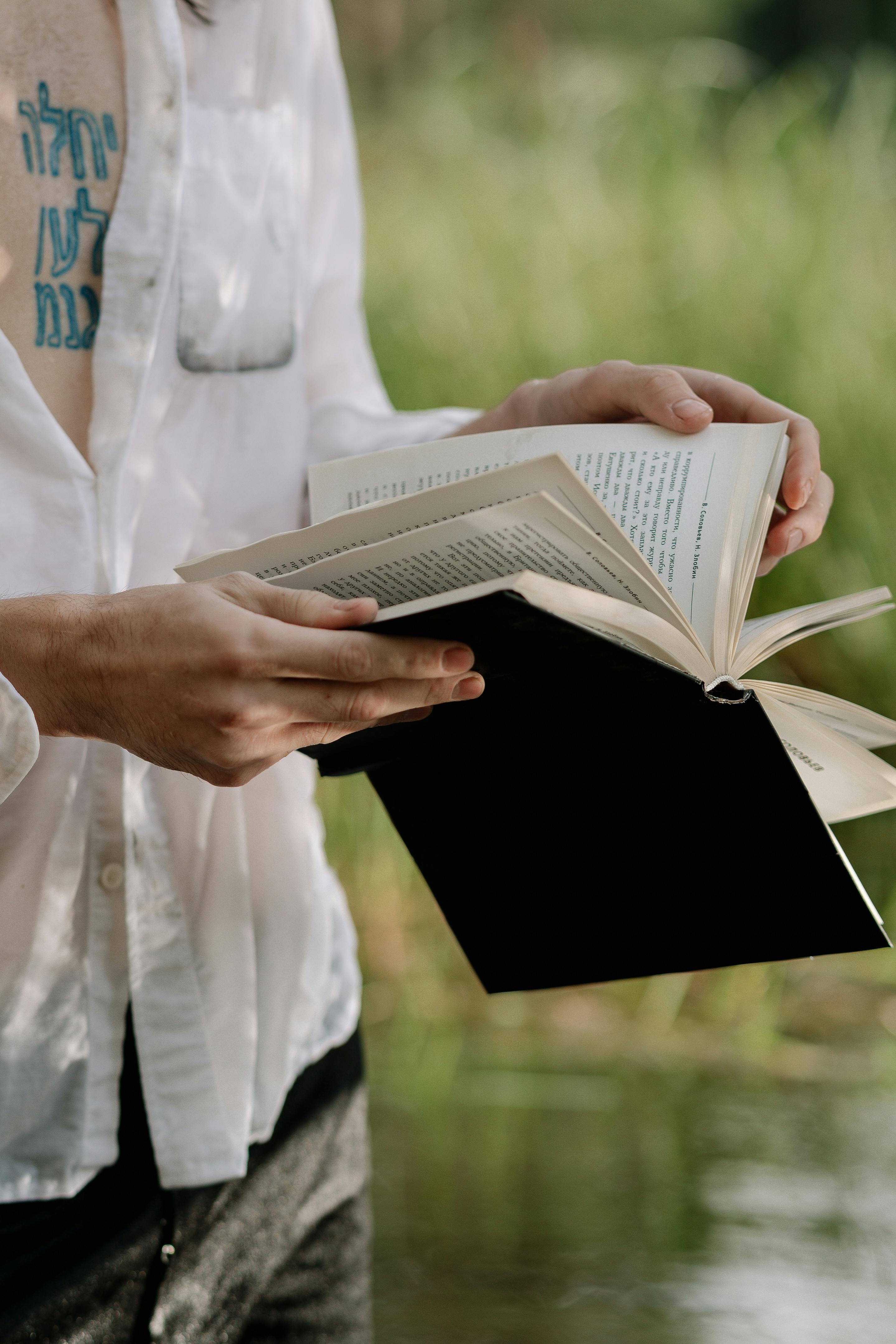 A Person Flipping Pages of a Book · Free Stock Photo