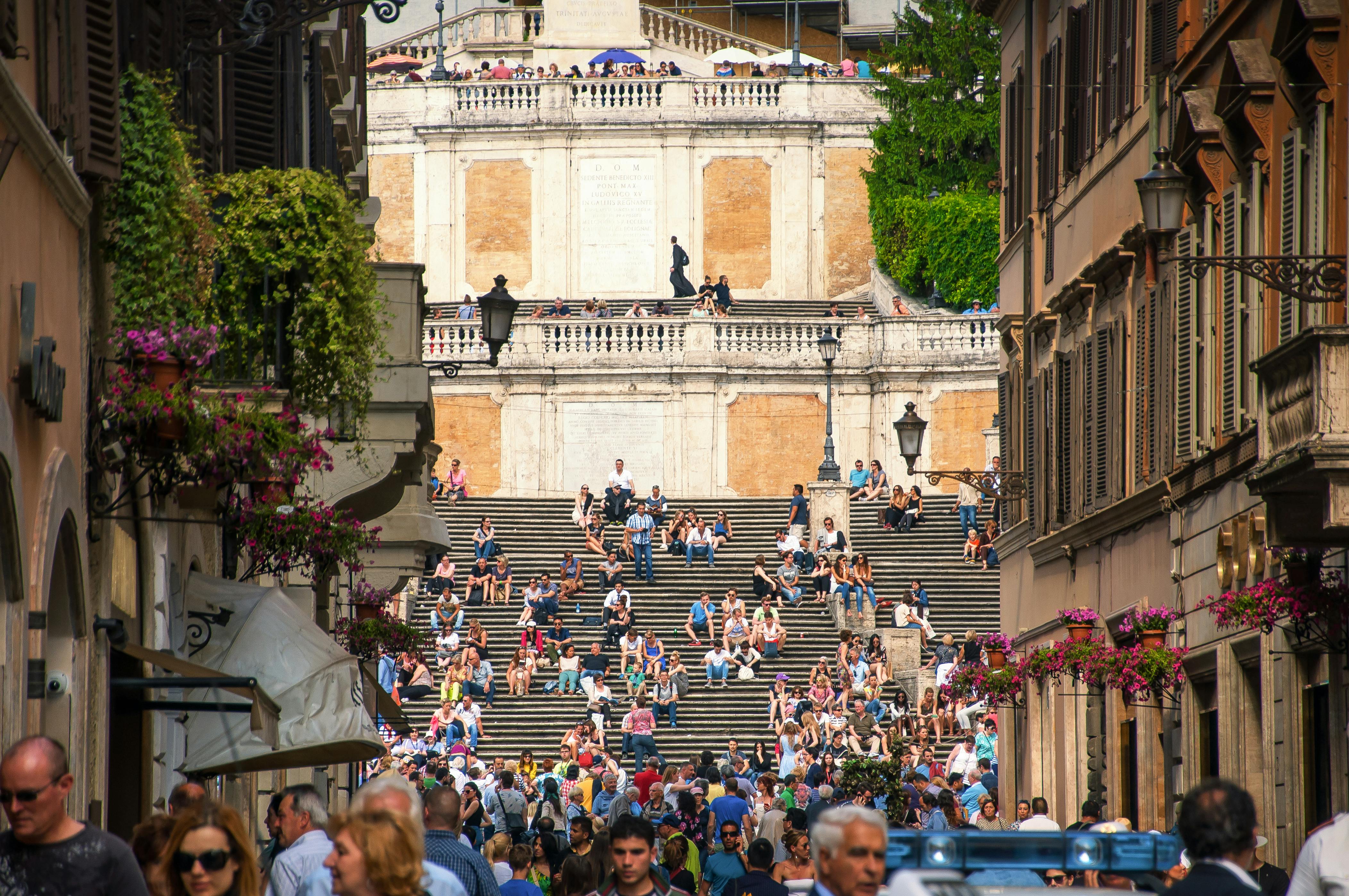 Group of people walking and sitting on street · Free Stock Photo