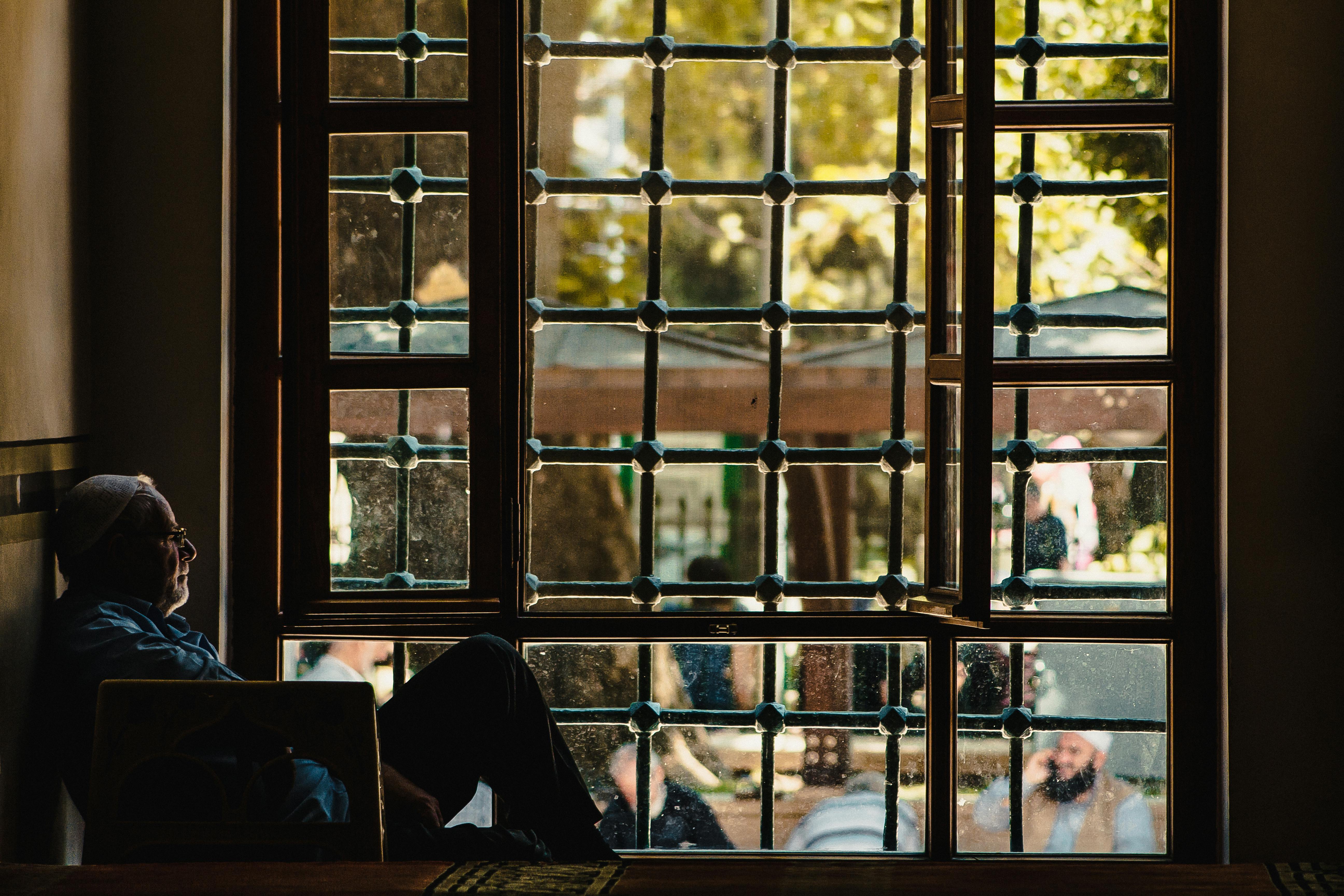 A Man Sitting Near the Window · Free Stock Photo