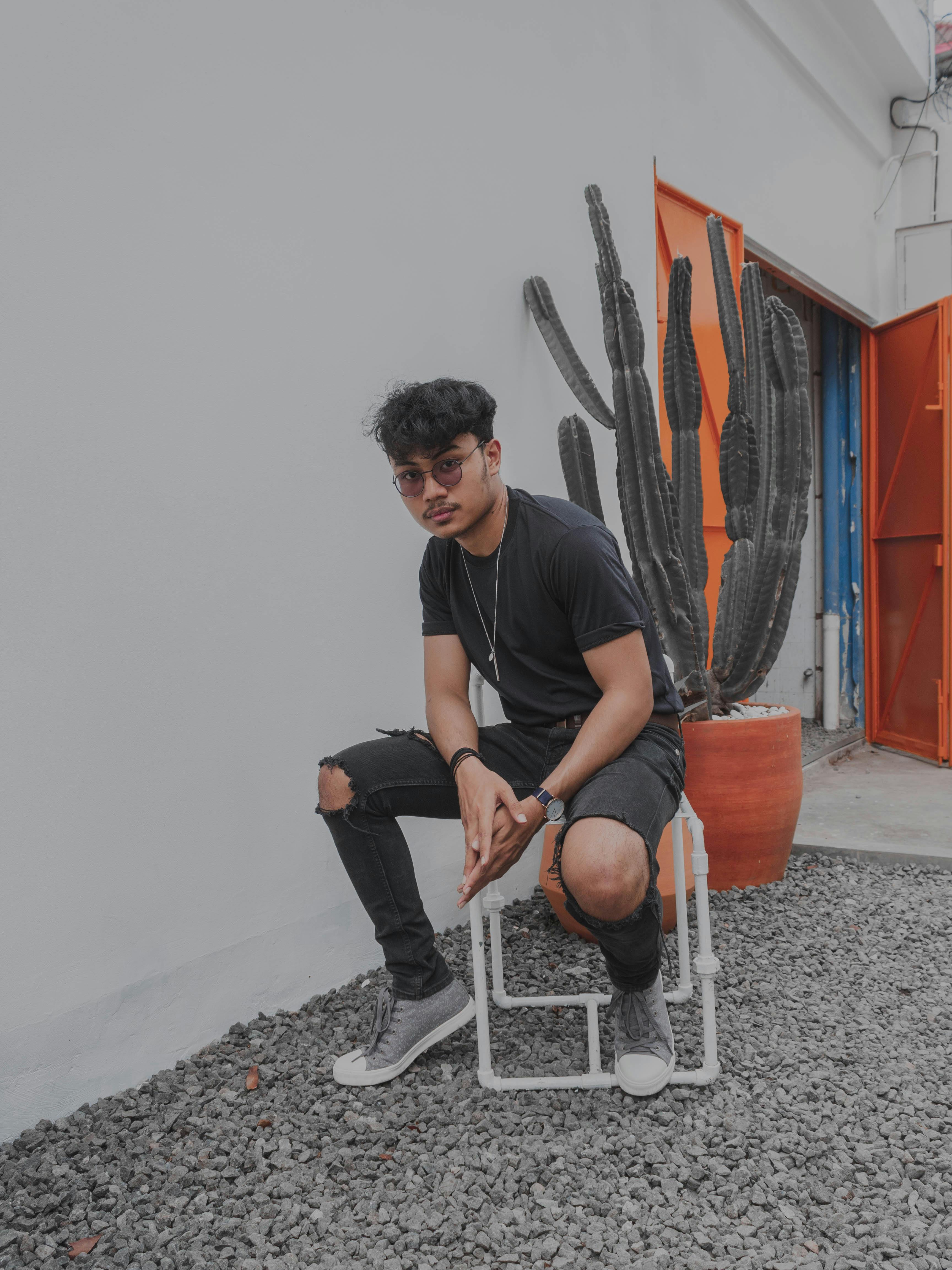 Trendy ethnic male chilling on balcony · Free Stock Photo