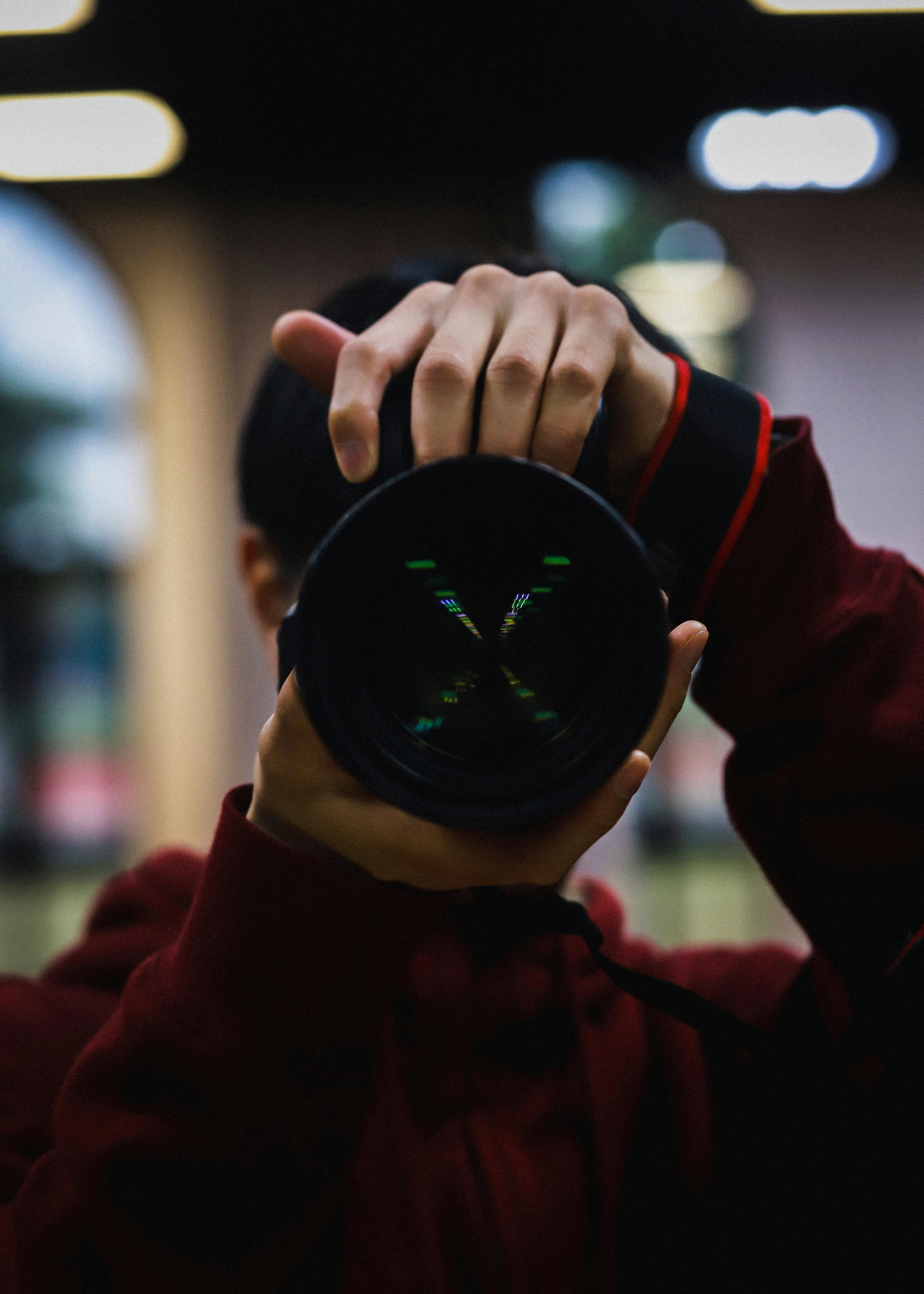 Photographer Hiding Face Behind Camer · Free Stock Photo