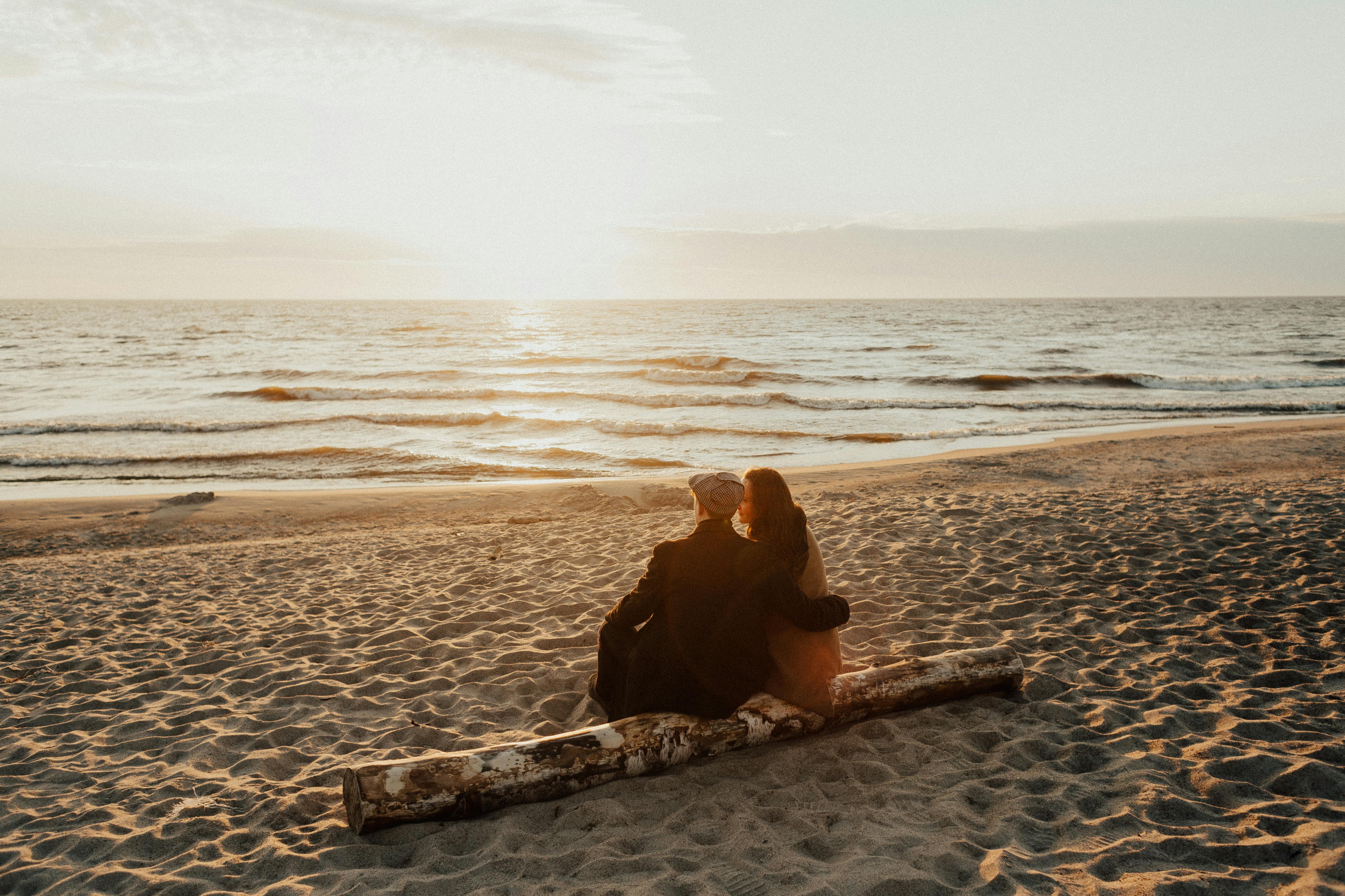 A Couple at the Beach During Sunset · Free Stock Photo