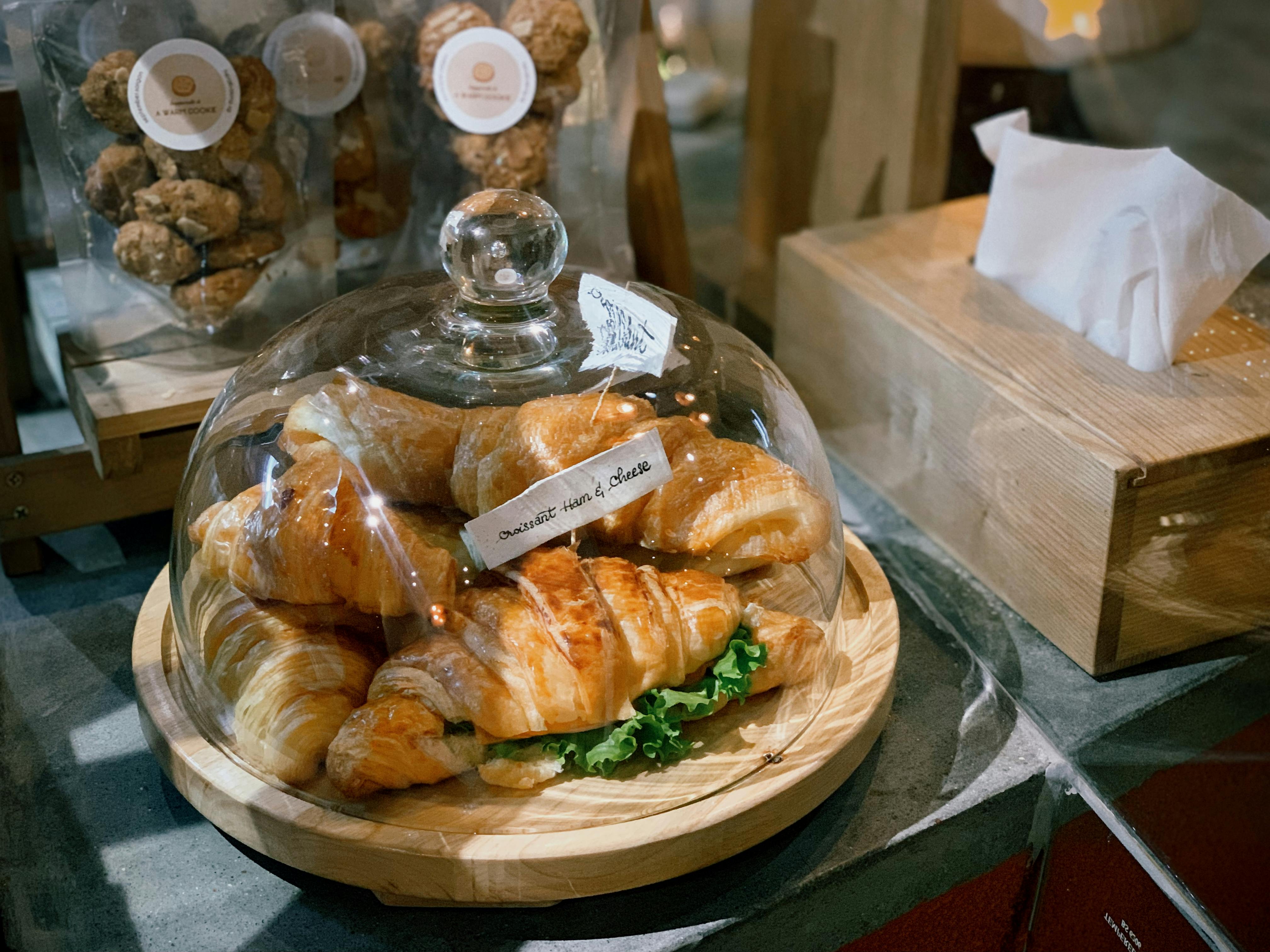 Delicious croissants and cookies near tissue box in bakery · Free Stock ...