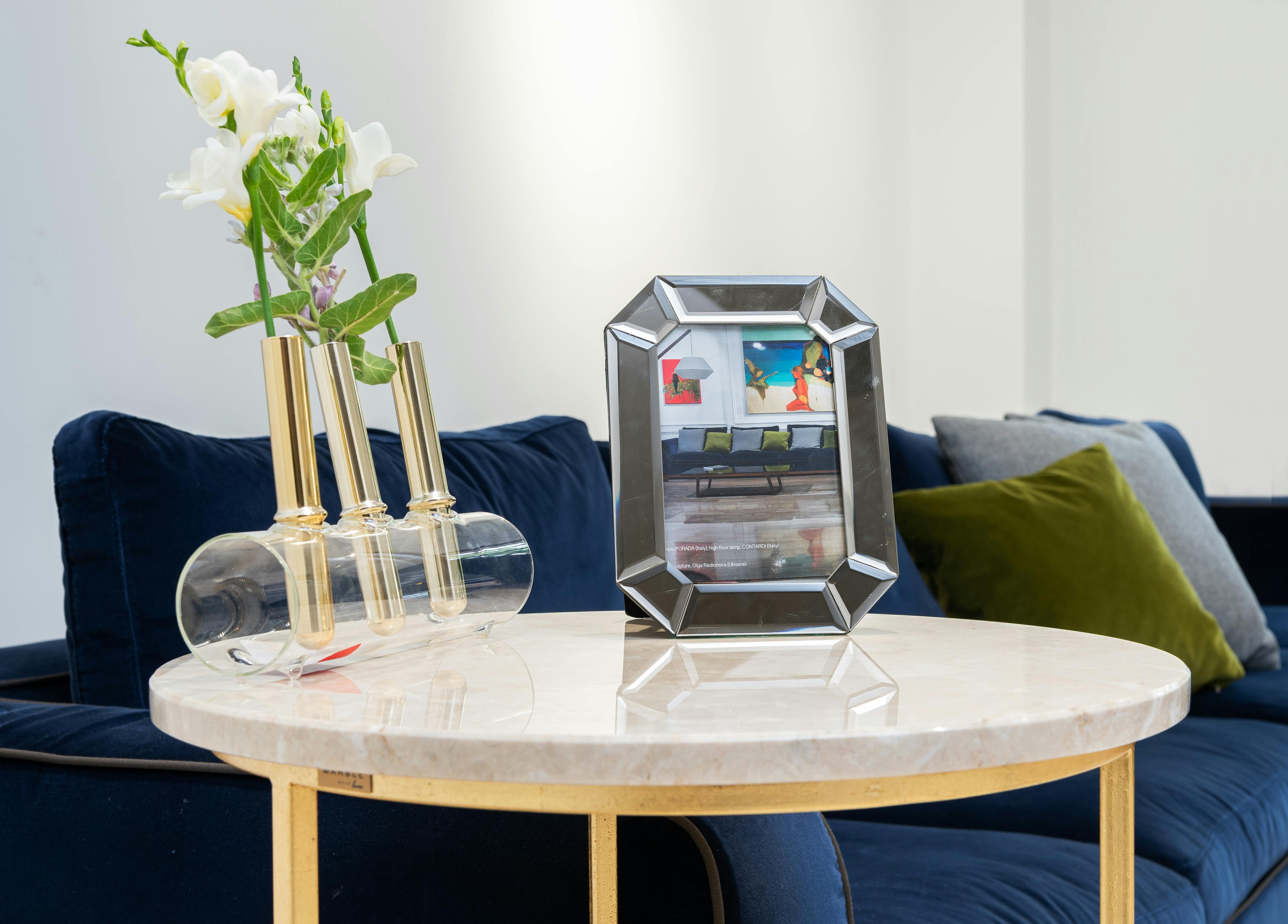 Flowers and stylish frame on table · Free Stock Photo