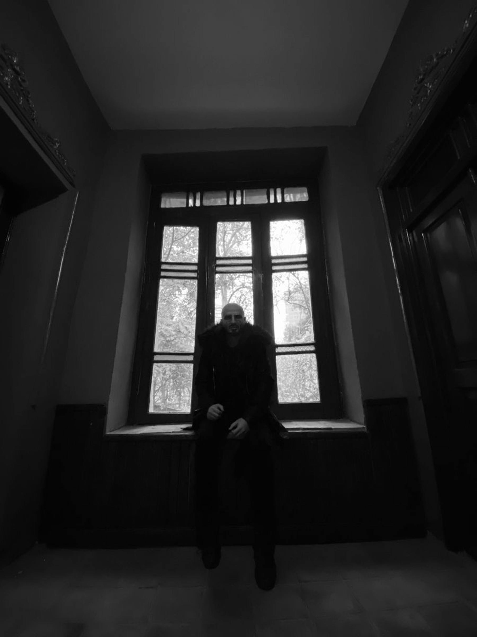 Man Standing Beside Window With Curtain · Free Stock Photo