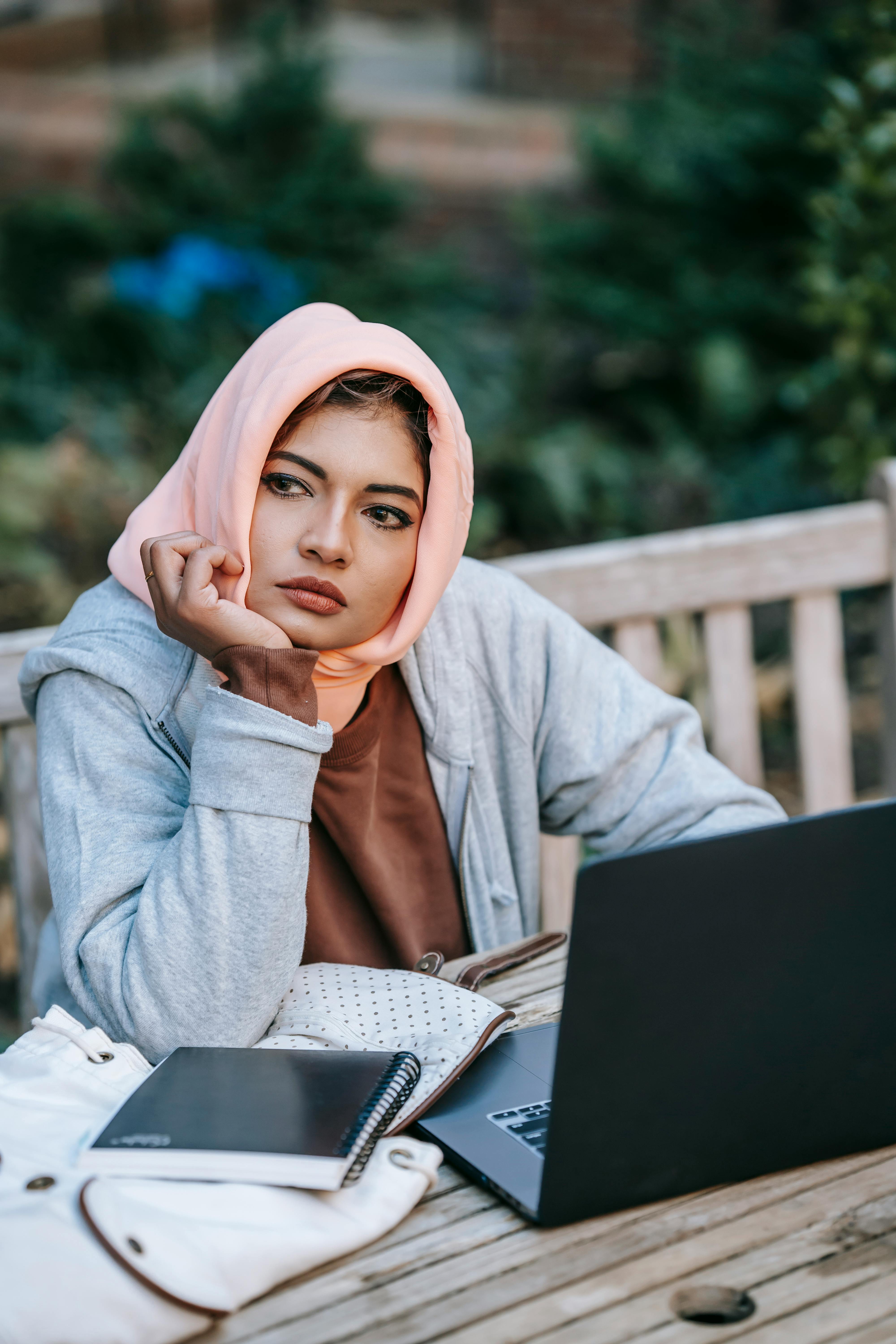 Pensive freelancer with laptop in park · Free Stock Photo