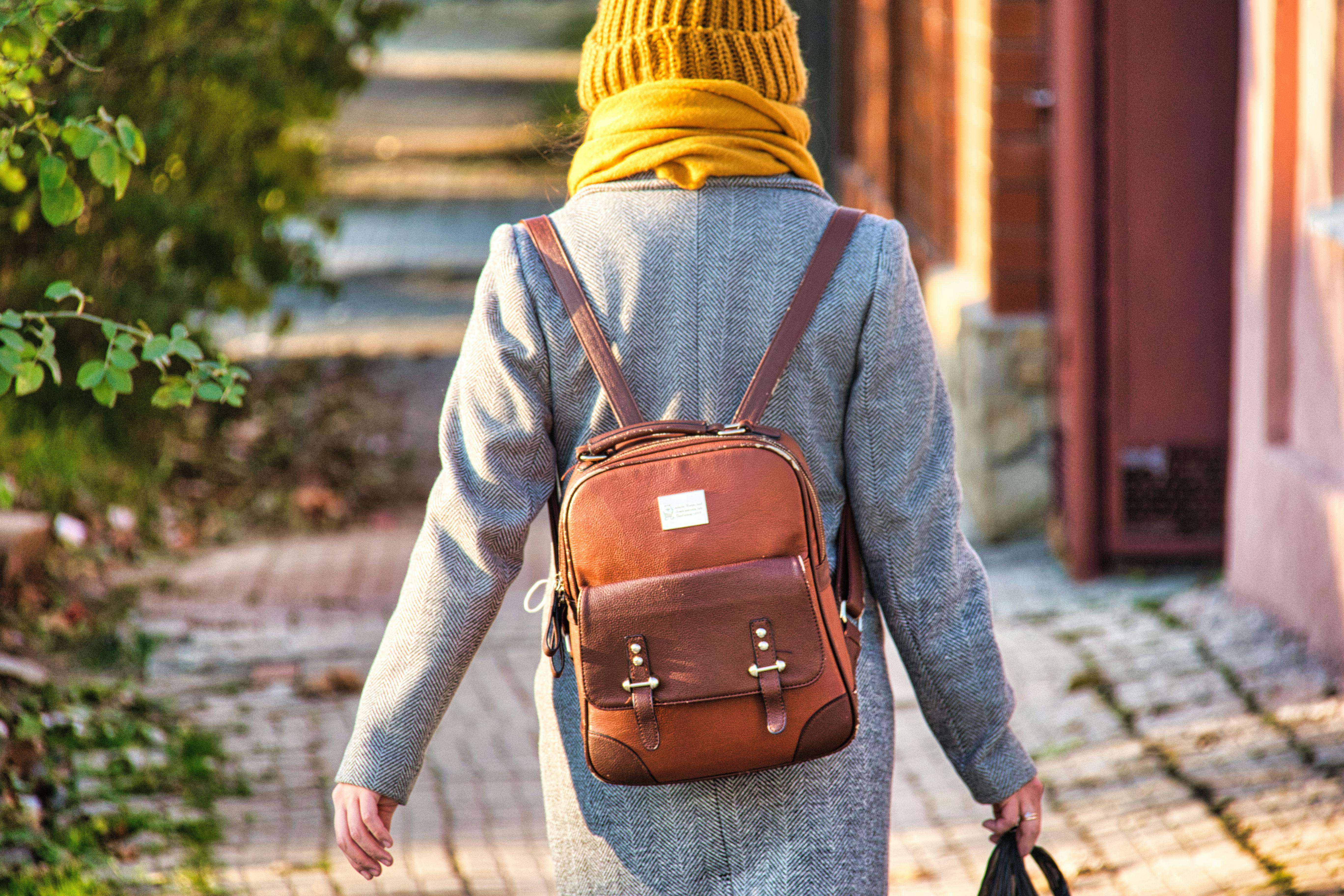 Person Wearing Black Hooded Jacket Standing on Escalator While Holding ...