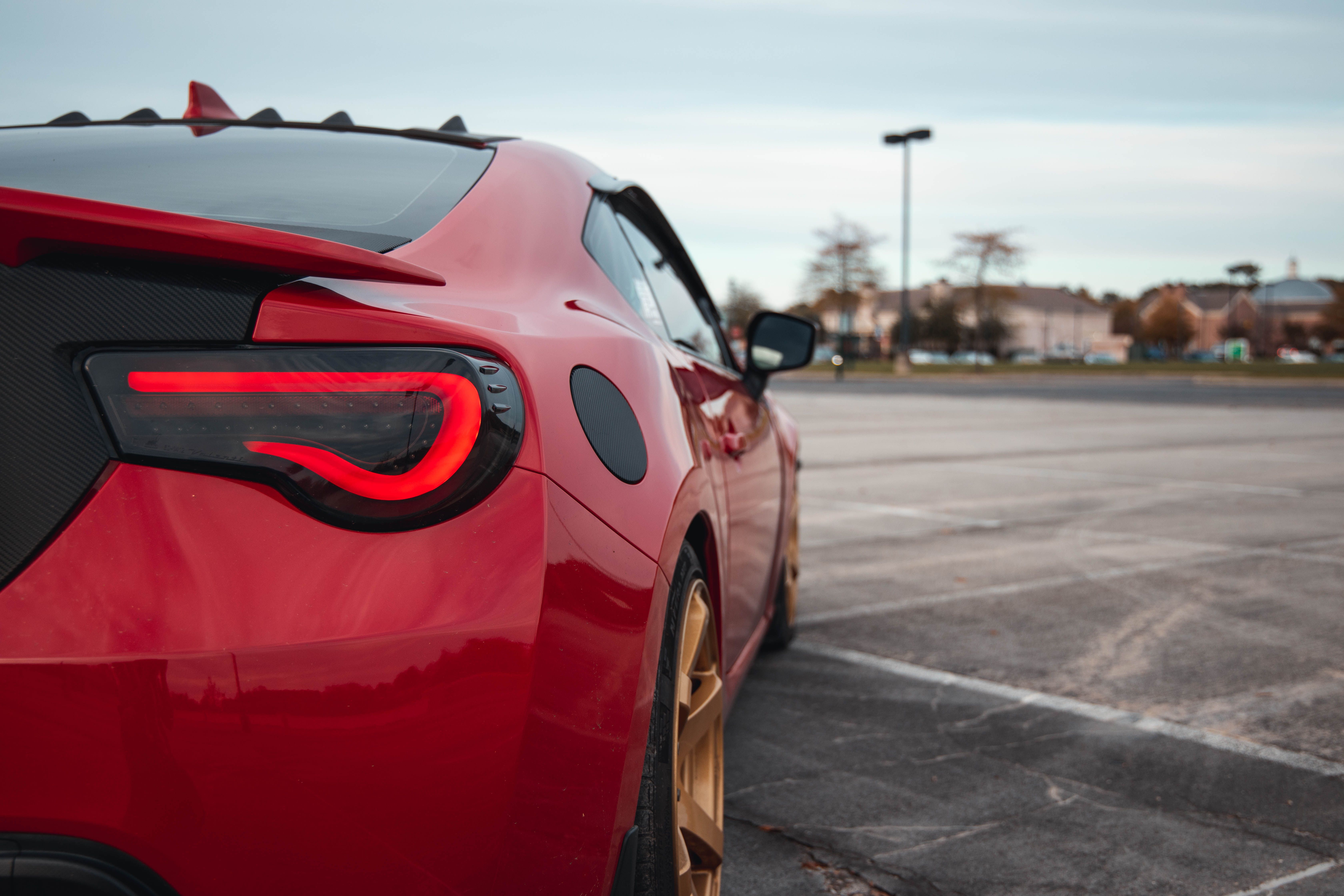 Rear of Modern Luxury Red Car Standing in Street · Free Stock Photo