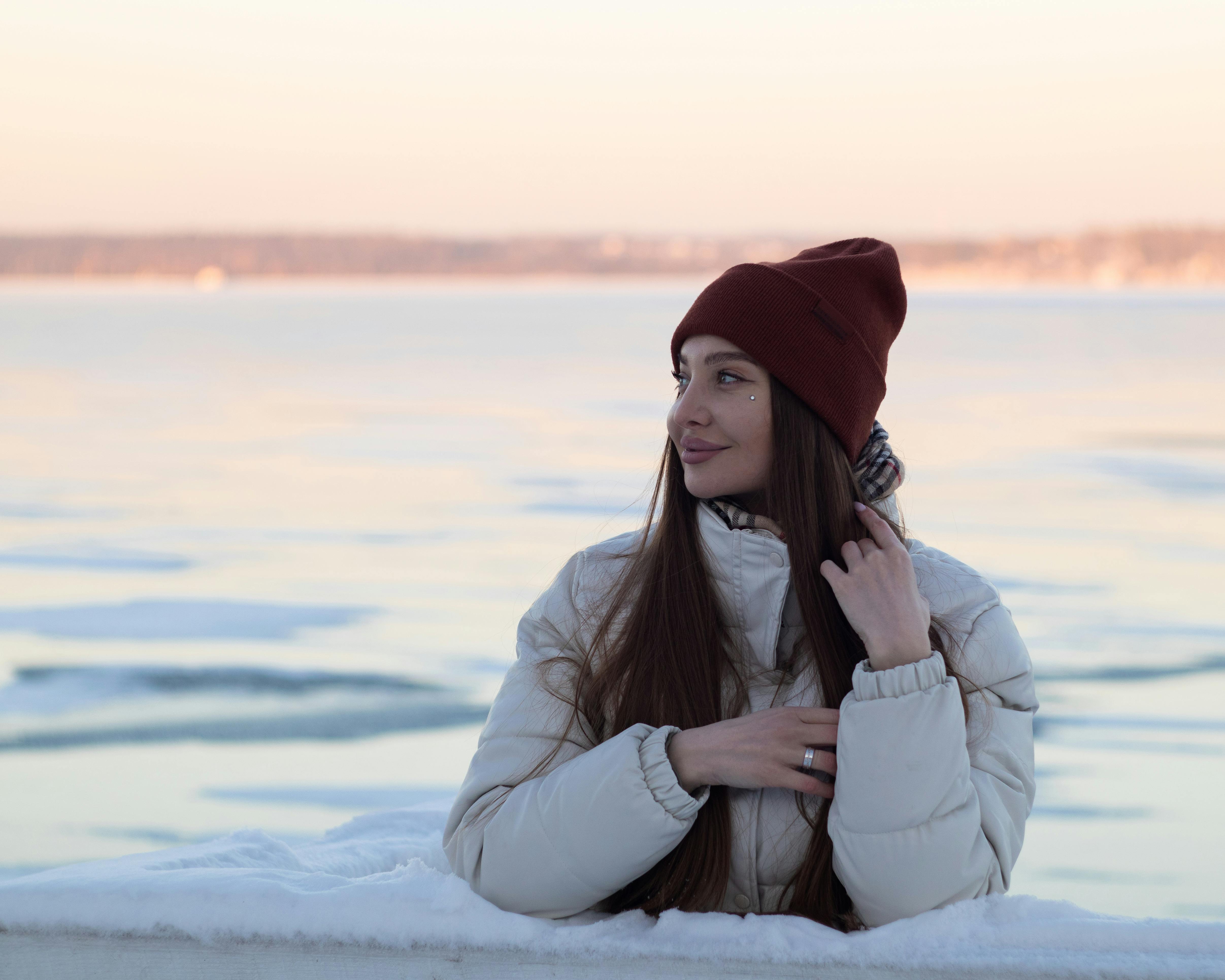 A Woman Wearing a Jacket and a Beanie · Free Stock Photo