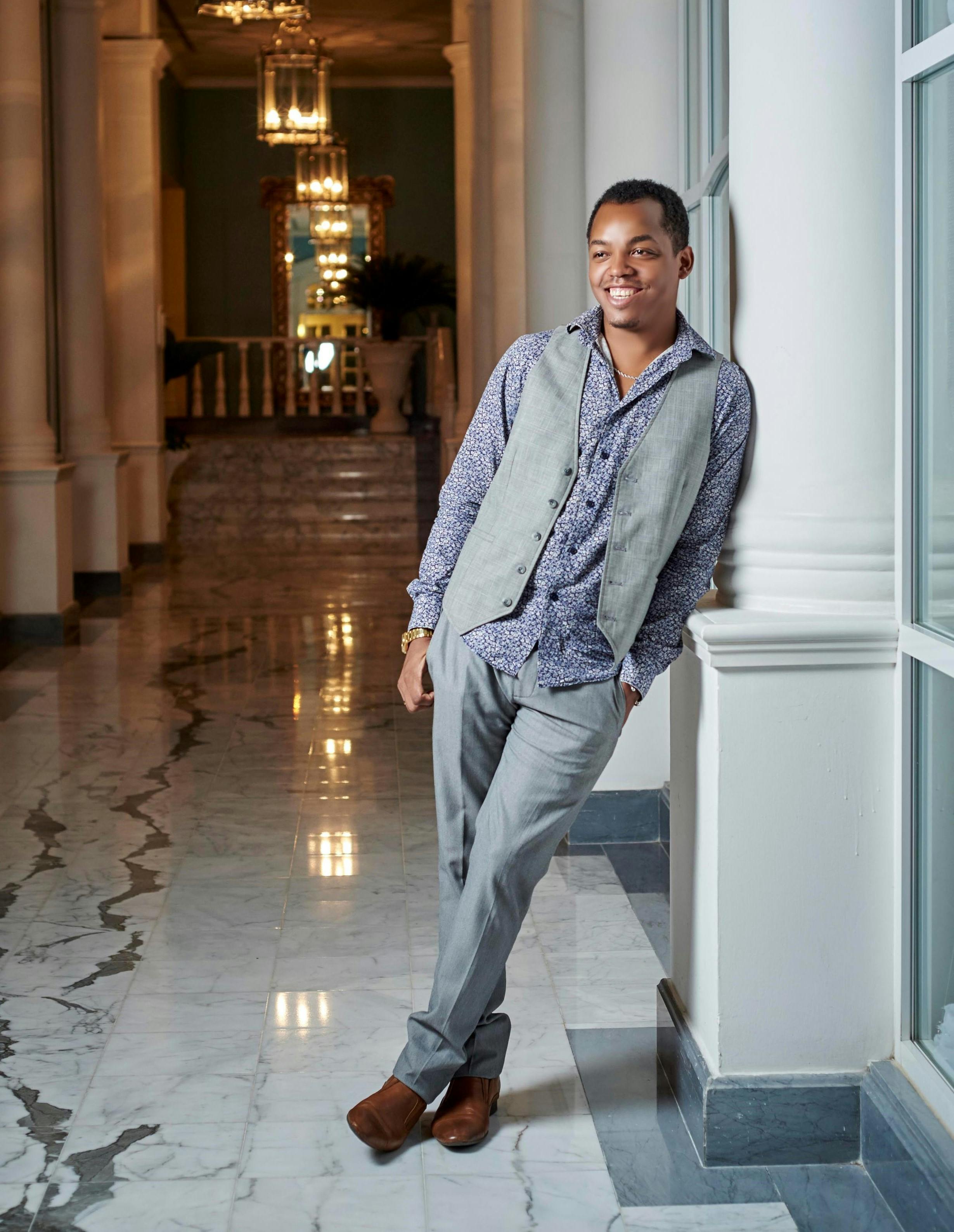 Man in Knit Vest leaning on Concrete Staircase with Railing · Free ...