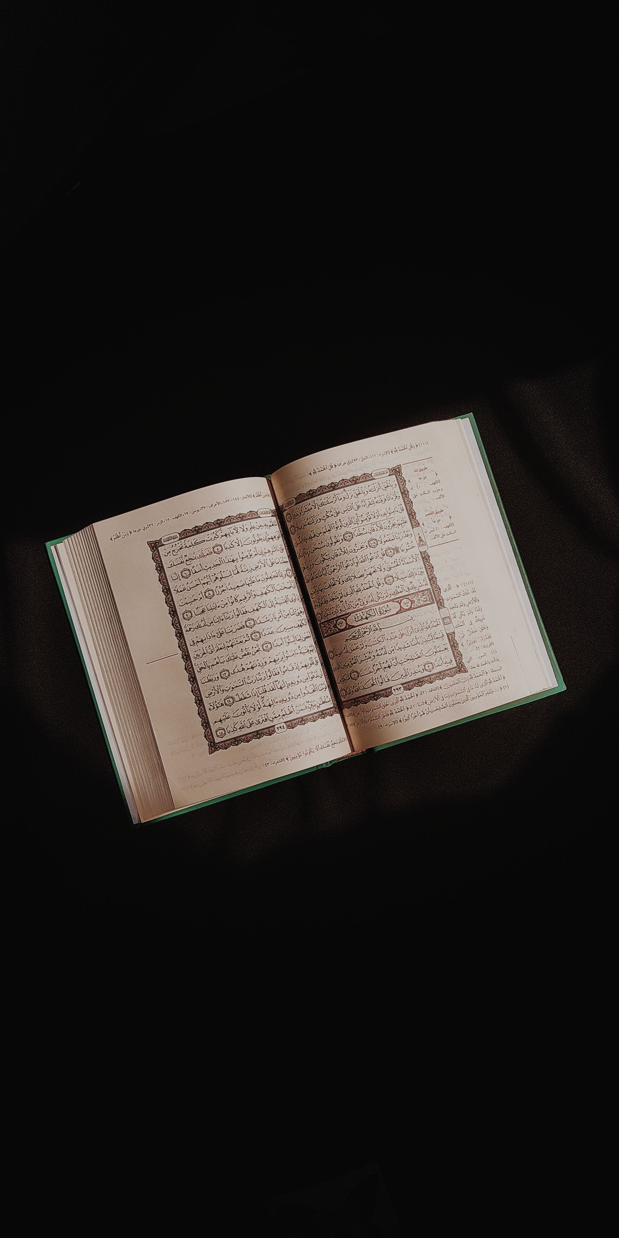 An Open Koran on a Wooden Table · Free Stock Photo