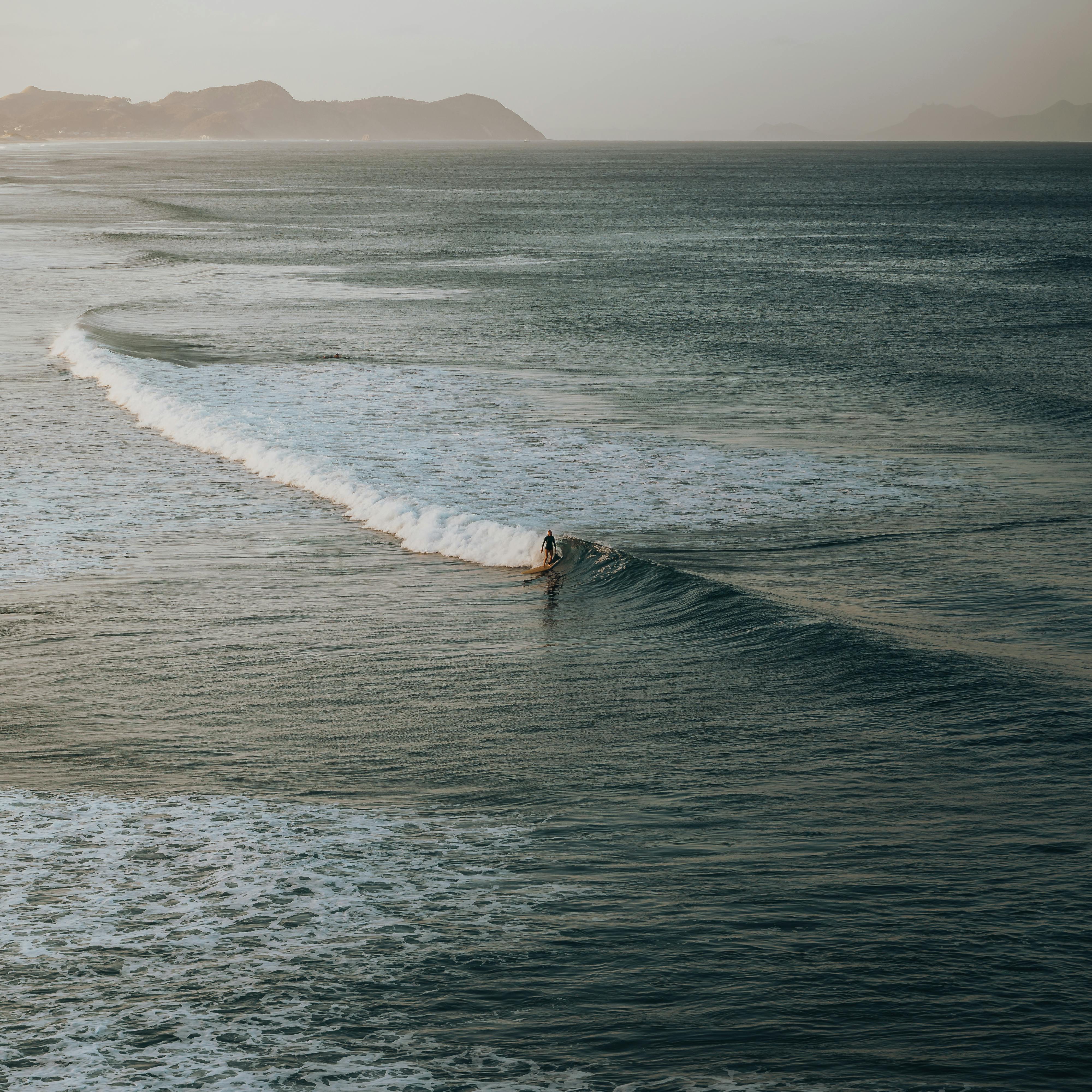 Aerial View Of People Surfing On Sea Waves · Free Stock Photo