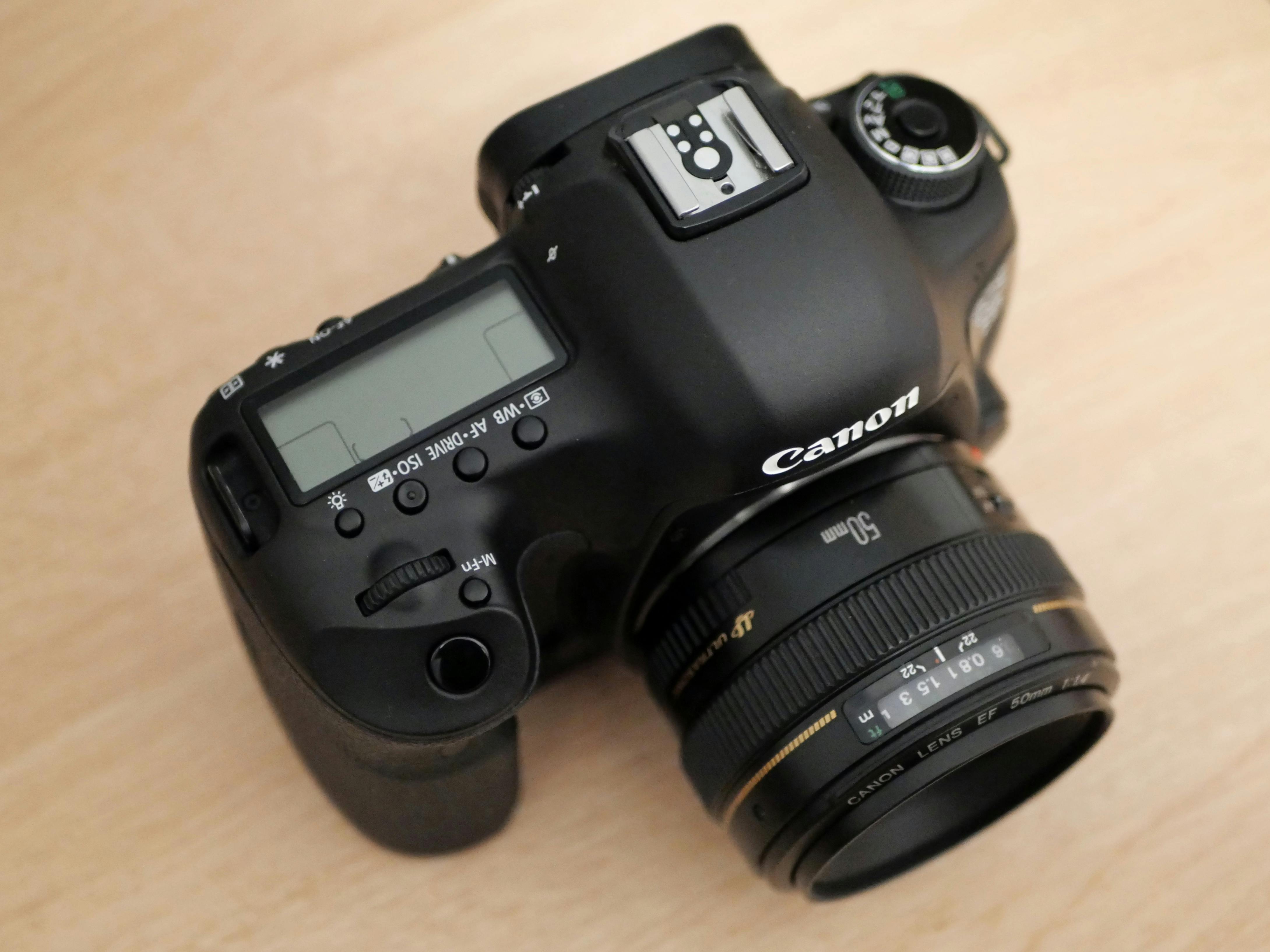 Black Canon Camera on White Wooden Table · Free Stock Photo