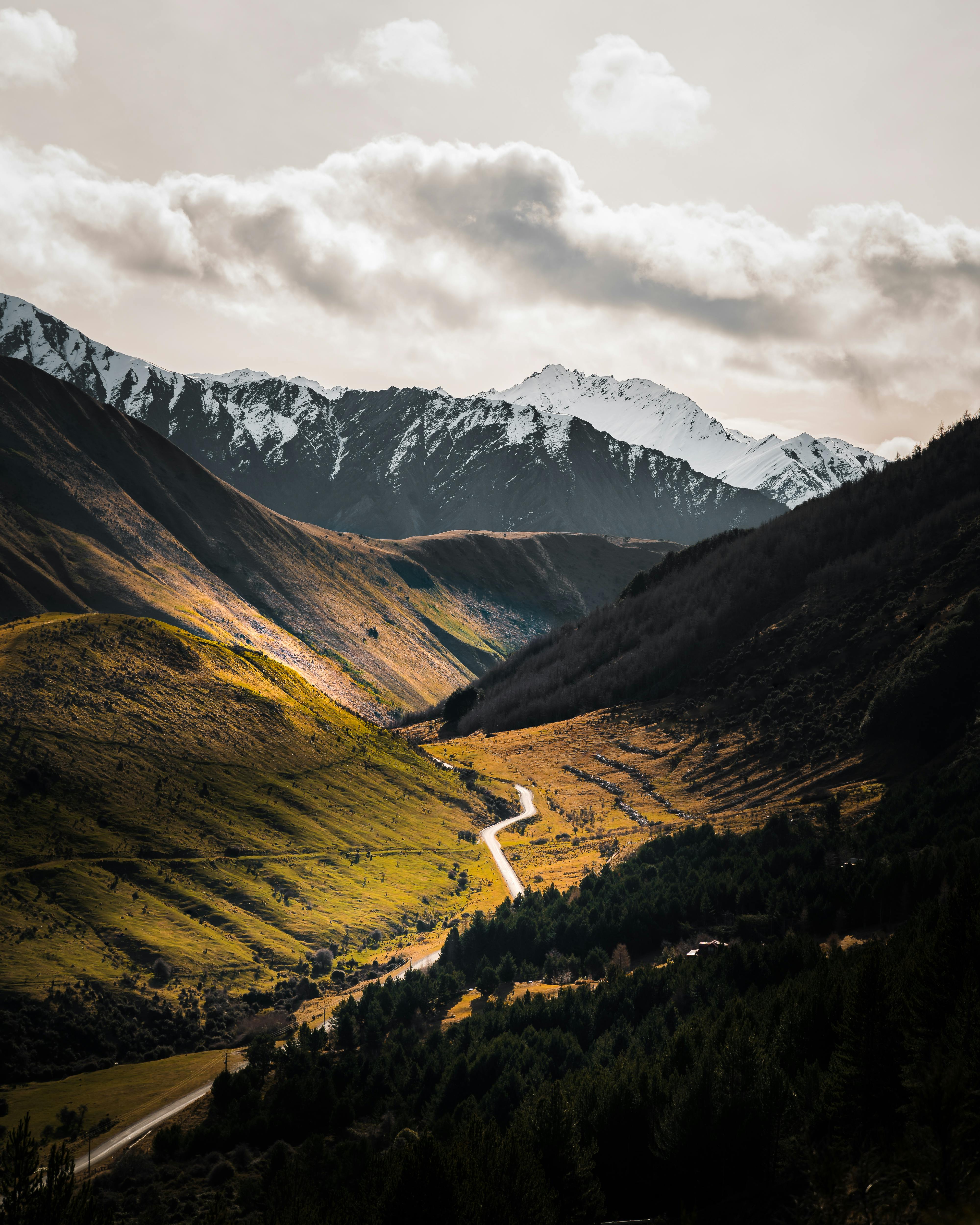 Photo of a Road Between Mountains · Free Stock Photo