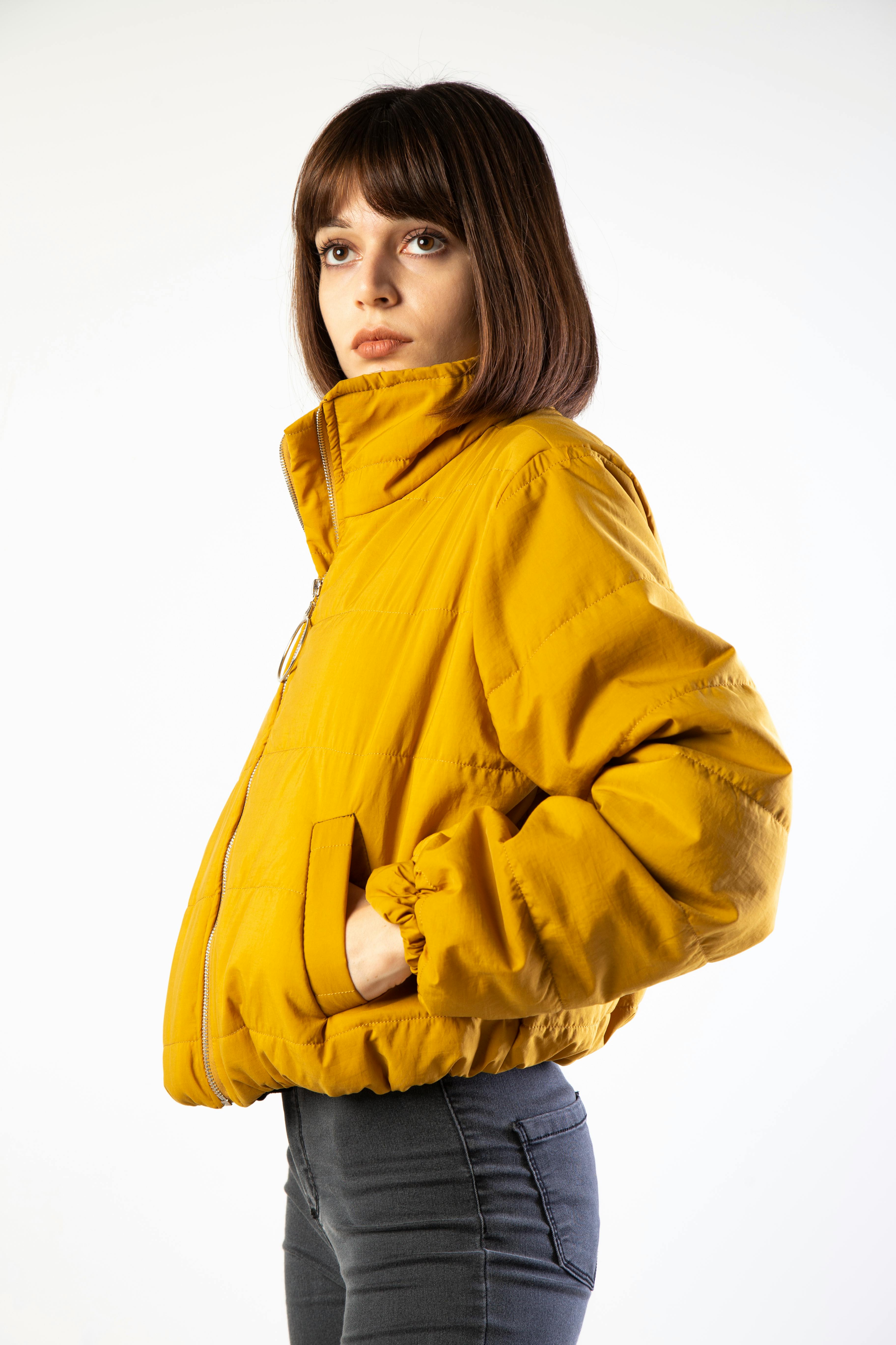 Woman Wearing a Yellow Jacket Looking Away · Free Stock Photo