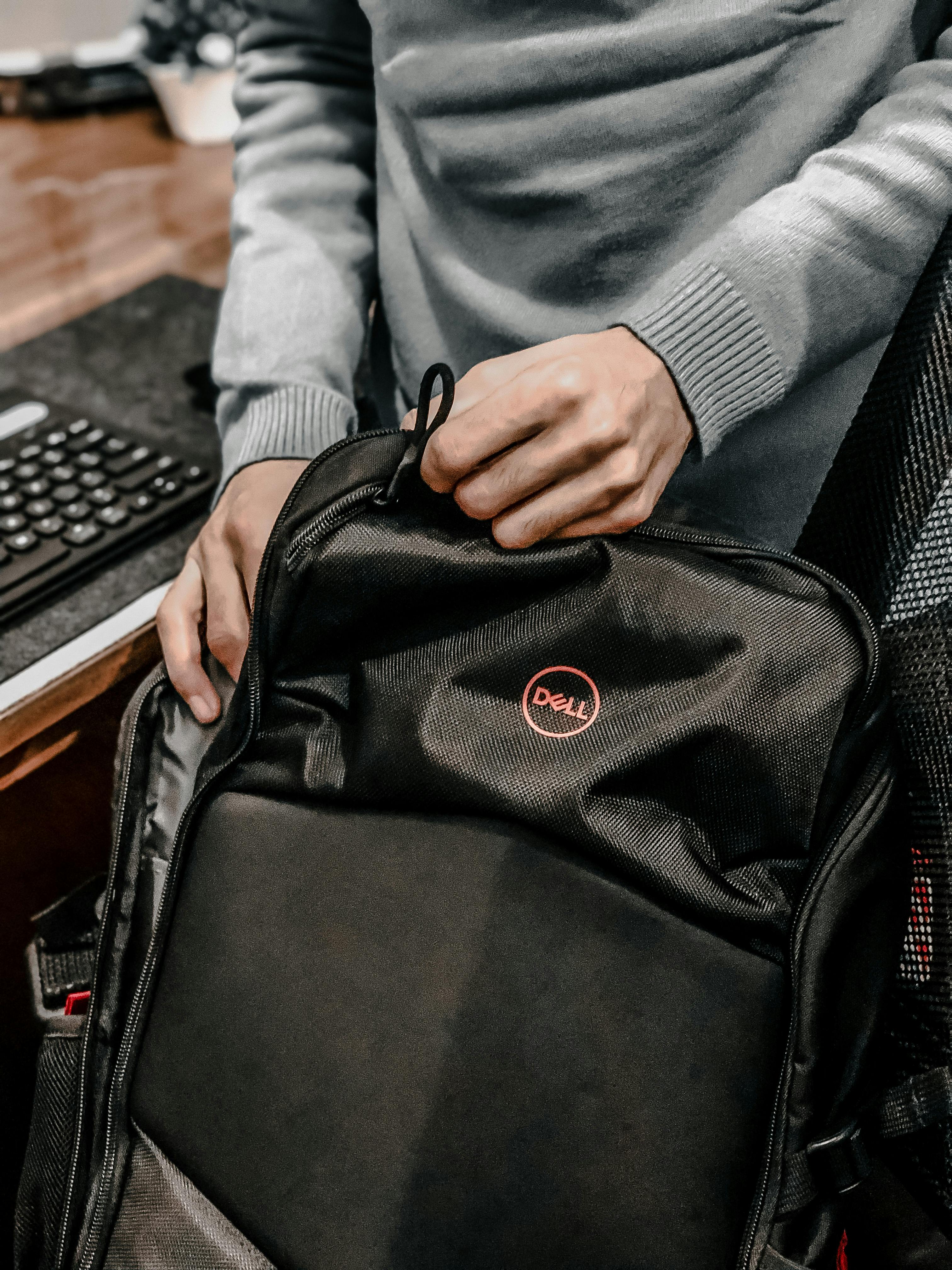 A Woman Opening the Lock of a Black Leather Briefcase · Free Stock Photo
