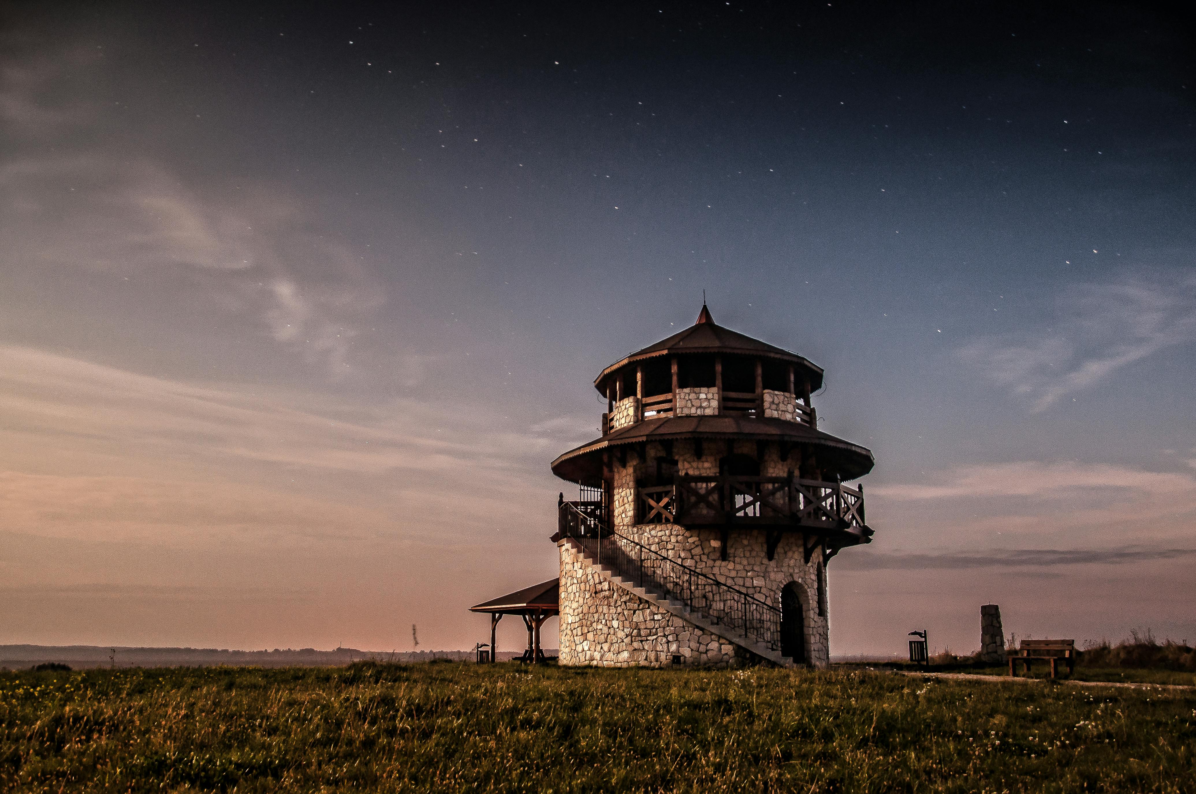 Old stone house with tower in field · Free Stock Photo