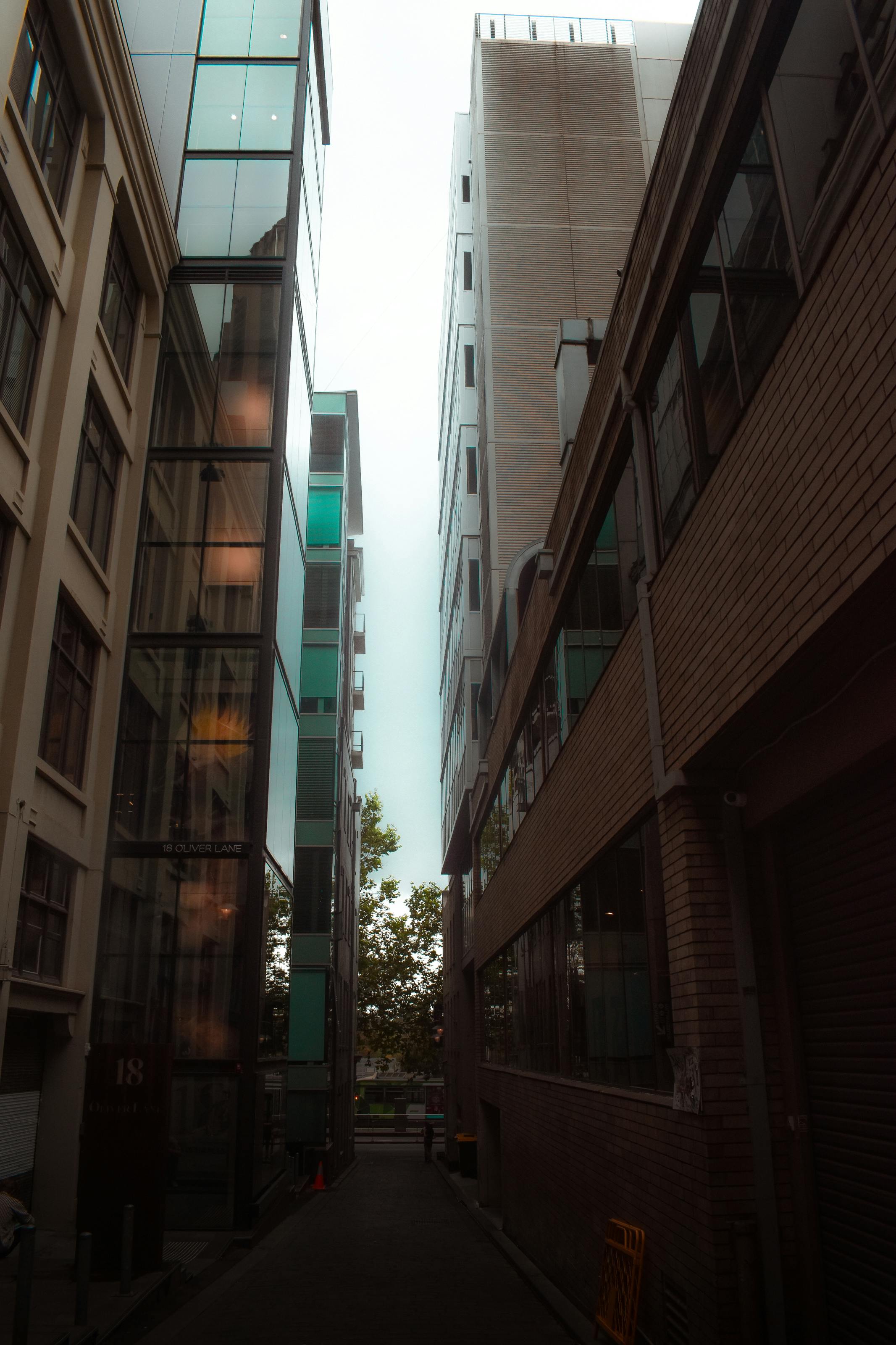 A Narrow Alley Between Concrete Buildings · Free Stock Photo