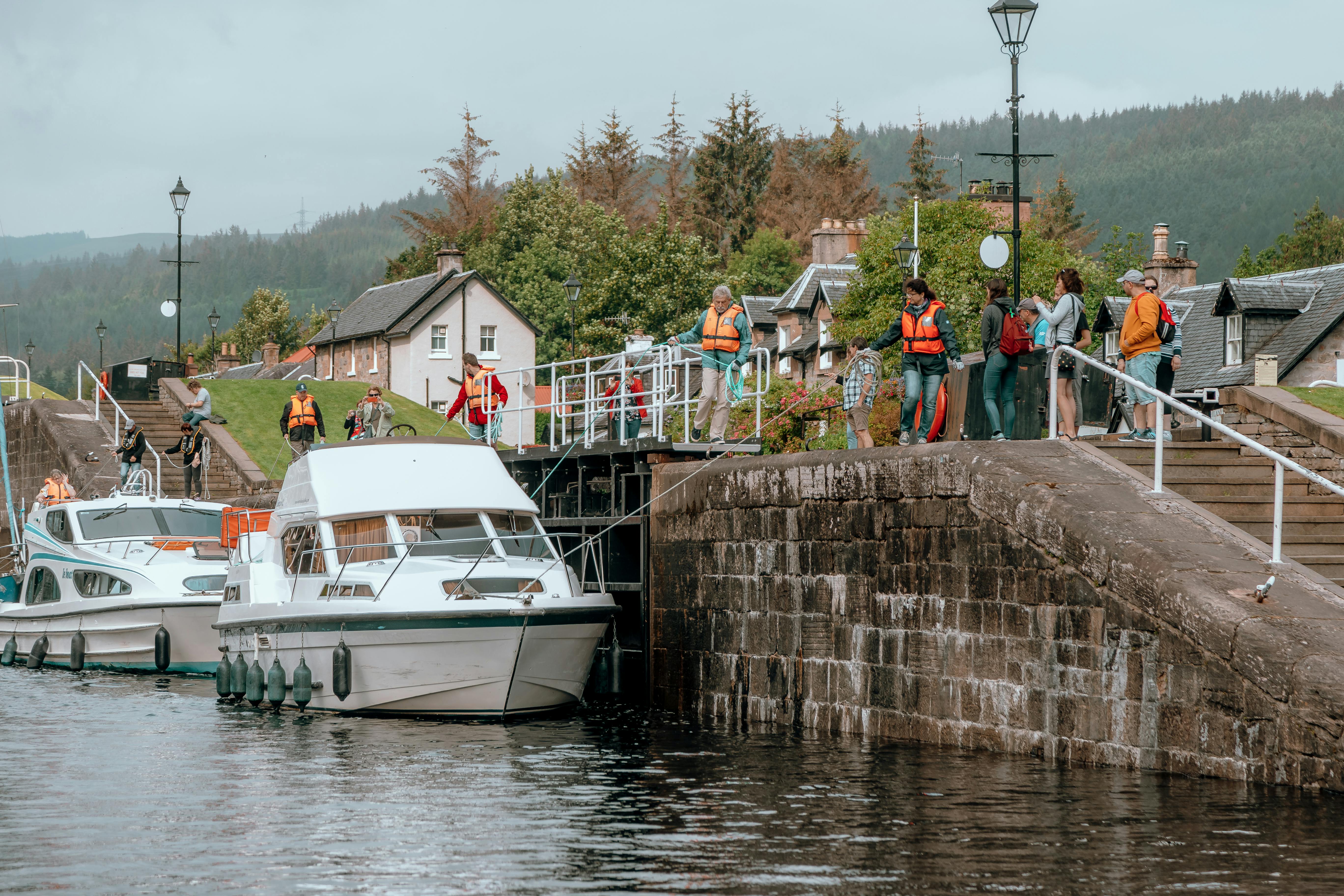 People Standing on Gray Concrete Docking Area · Free Stock Photo