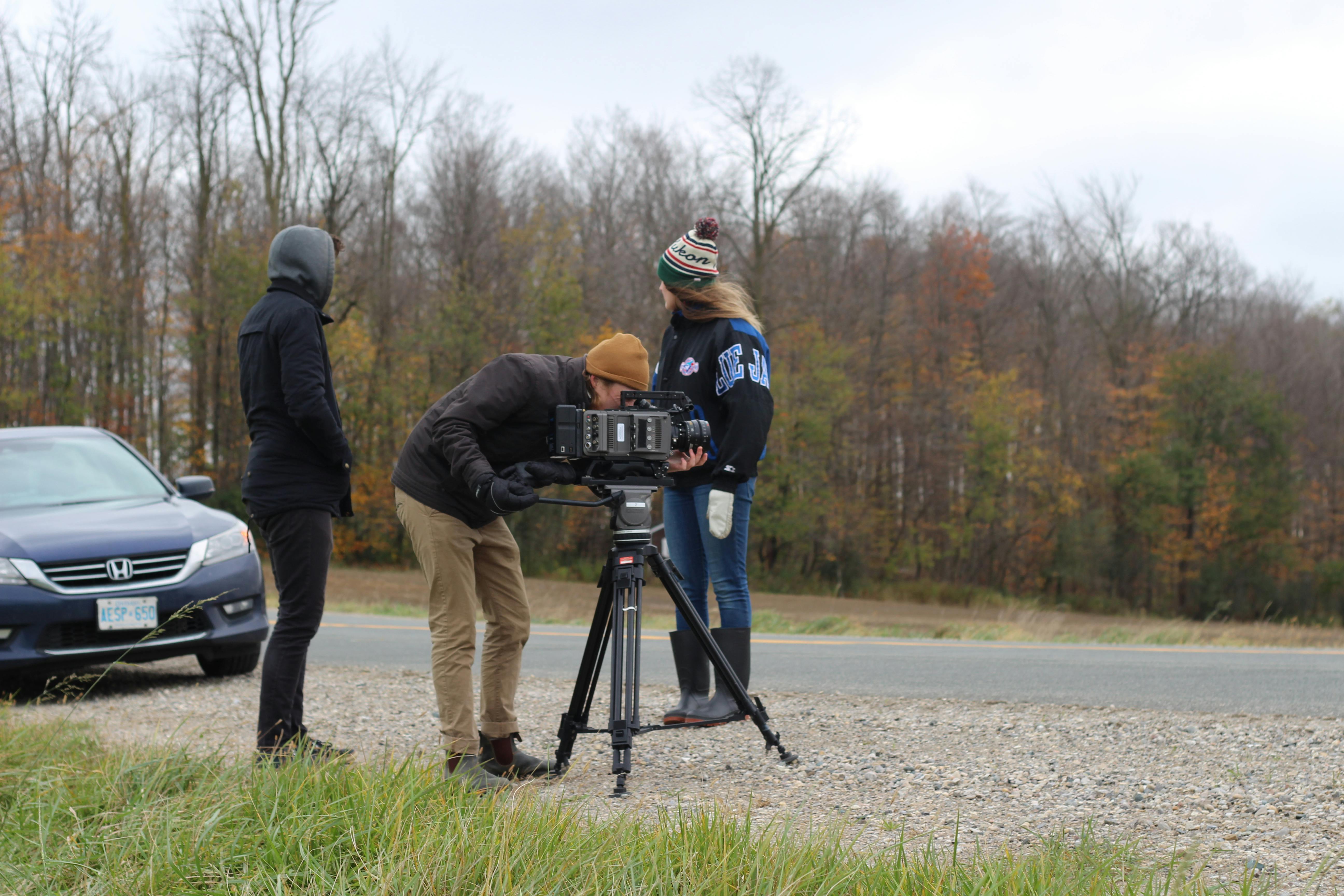 People Operating Camera on Roadside · Free Stock Photo