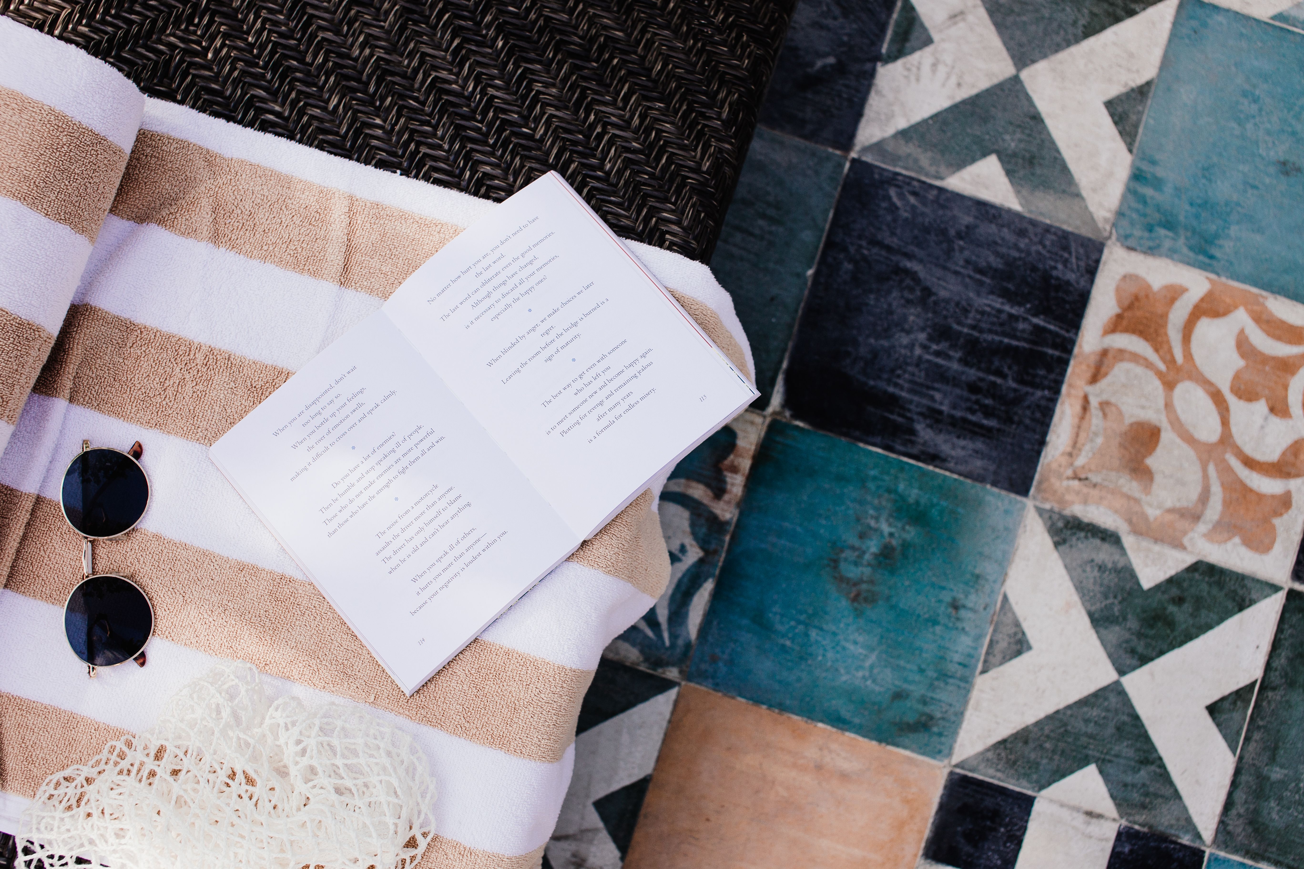 An Open Book on a Striped Textile · Free Stock Photo