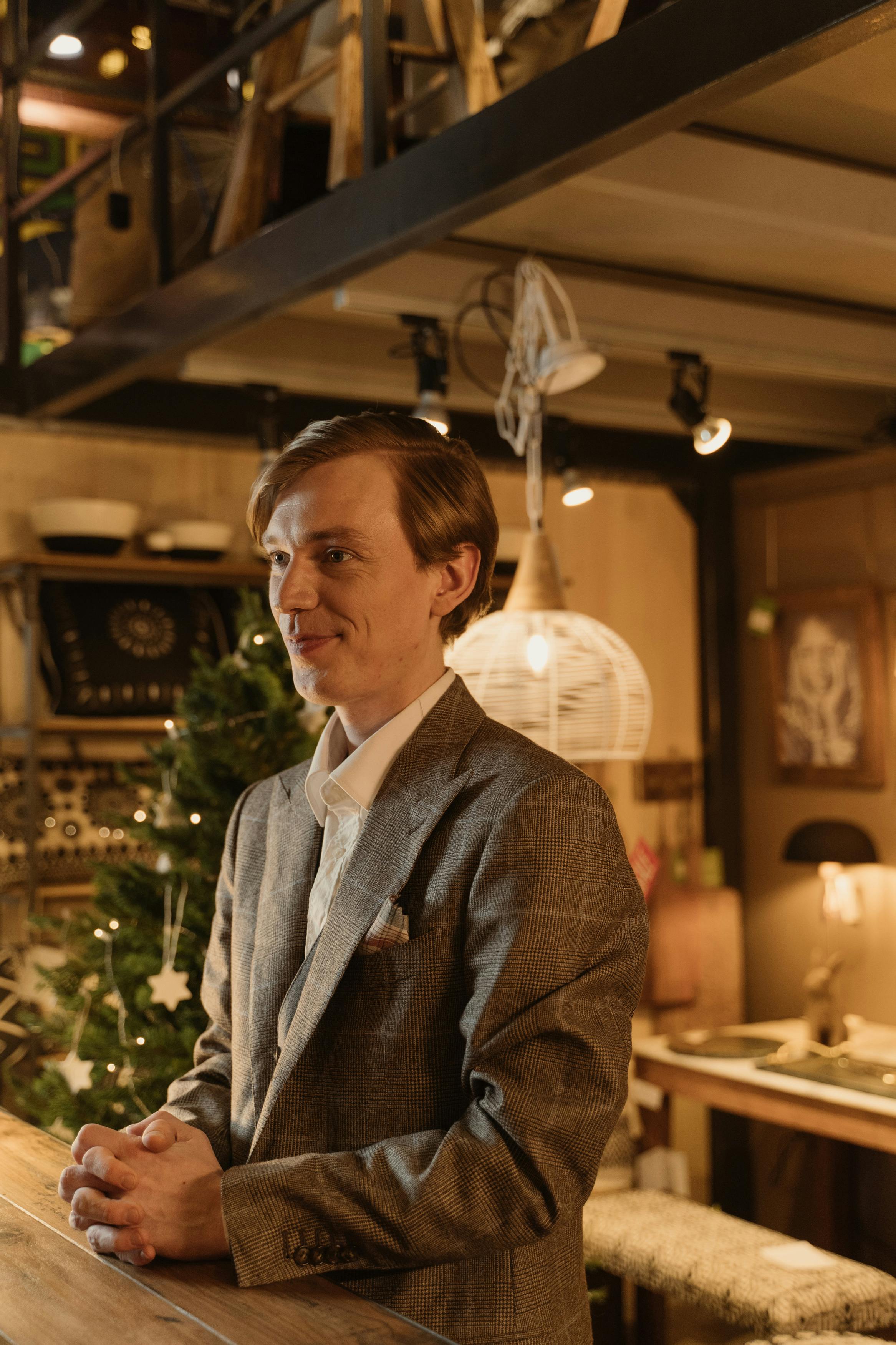 Salesman in Brown Suit Jacket Standing Near Brown Wooden Table · Free ...