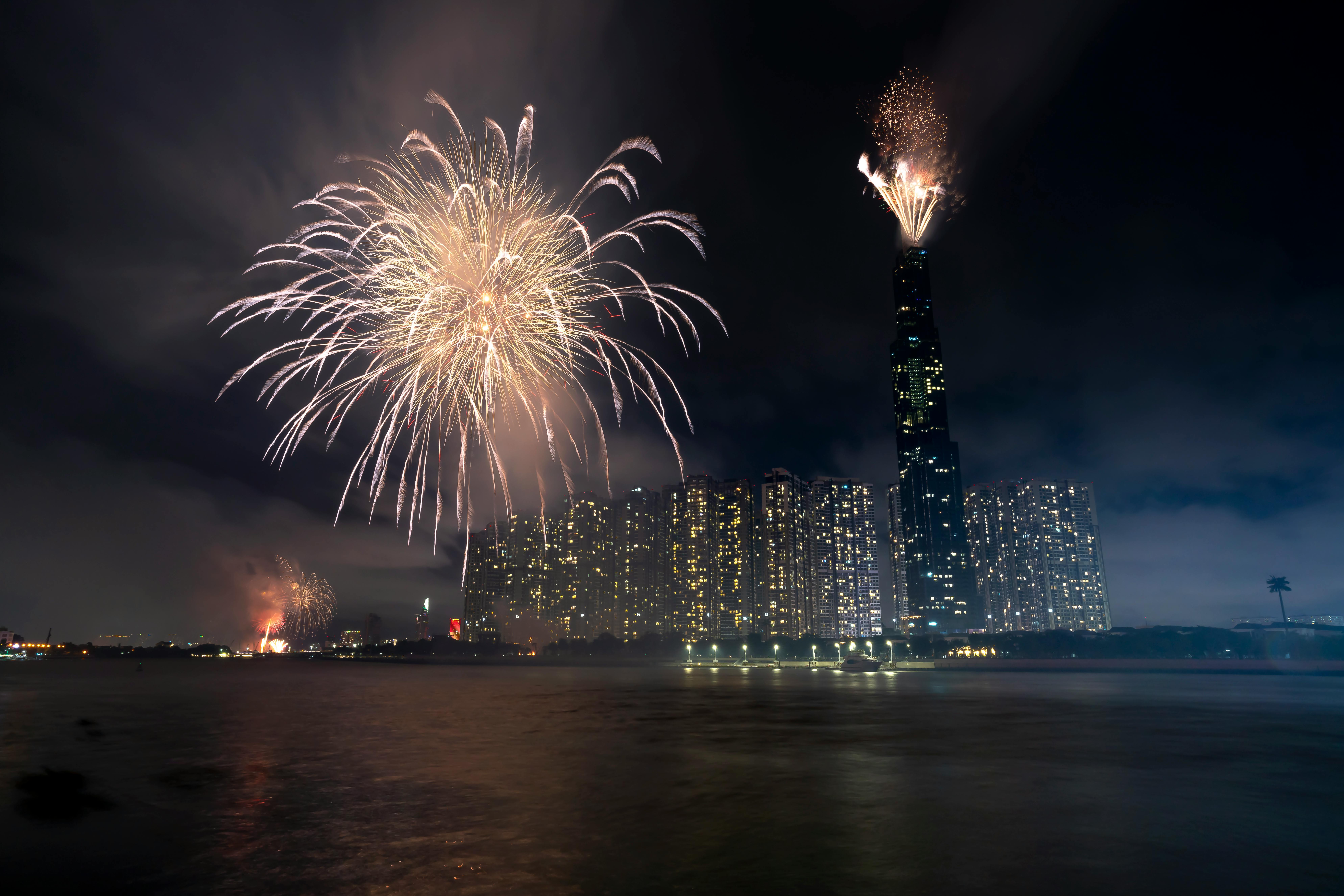 Illuminated city at night celebrating holiday with fireworks · Free ...