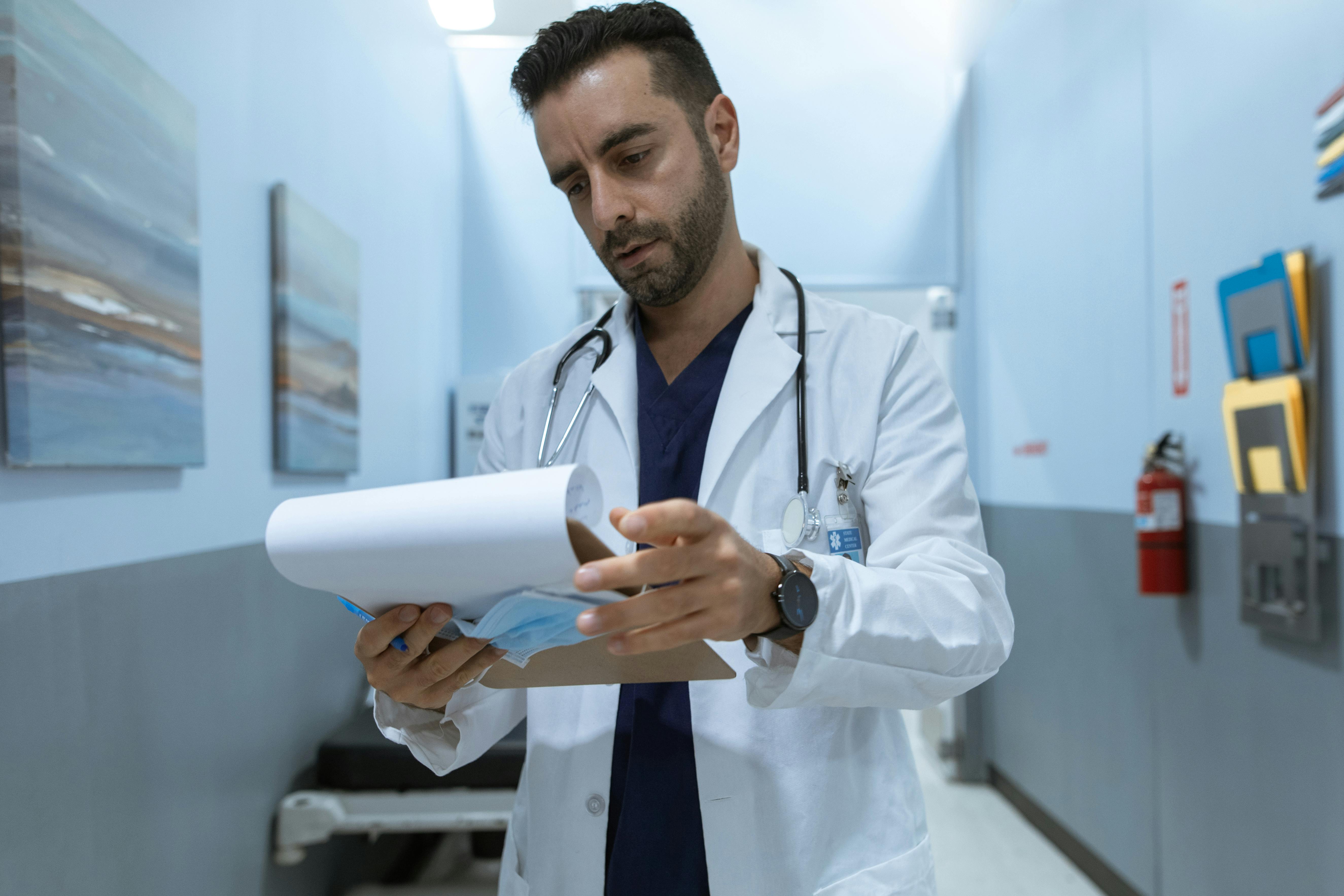 Doctor Reading a Medical Chart · Free Stock Photo