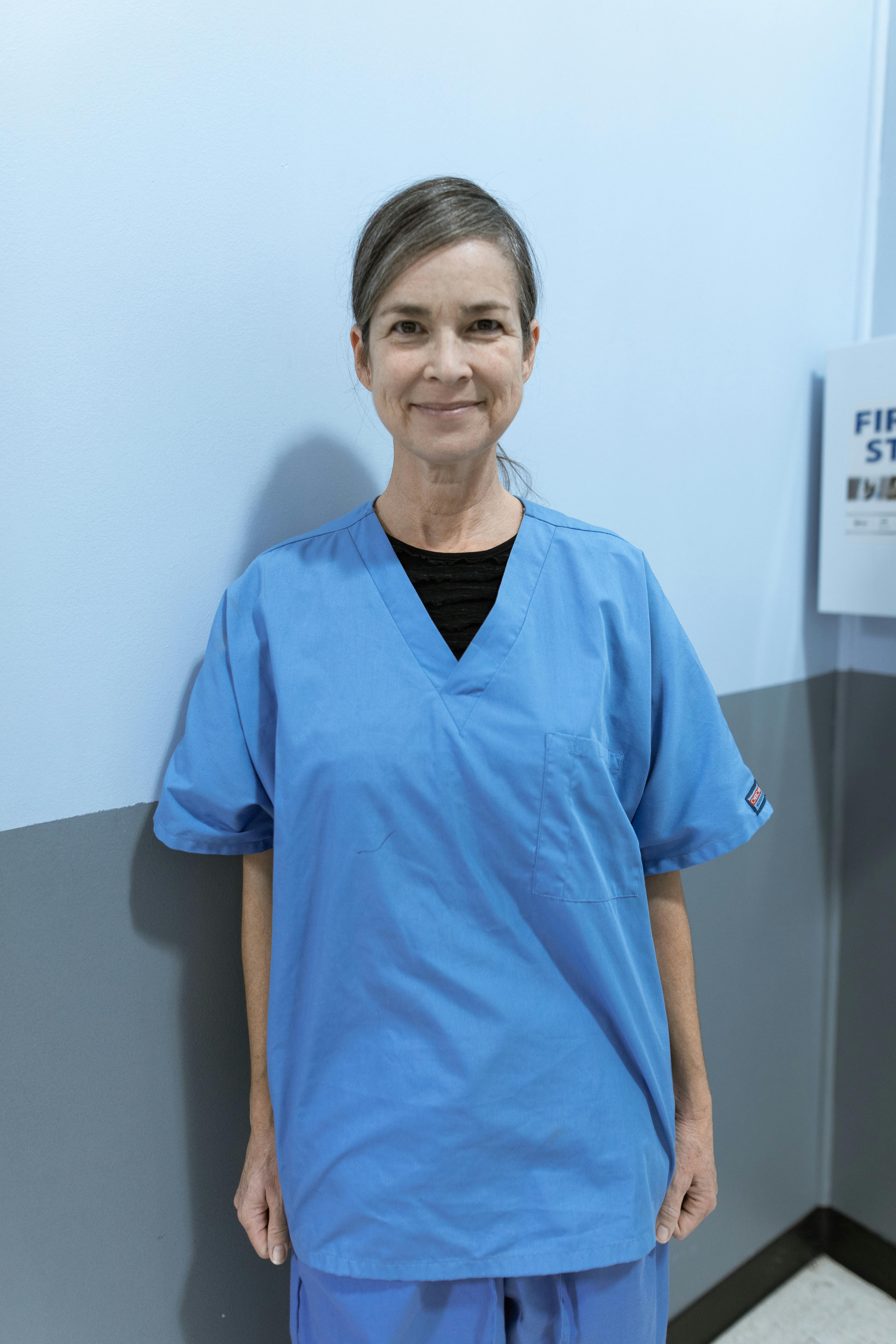 Nurse Wearing a Scrub Suit Smiling · Free Stock Photo